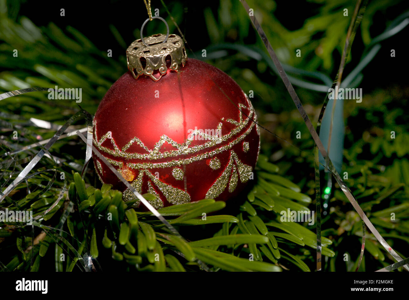 Red and silver shinning festive bauble seen in close up on a ...