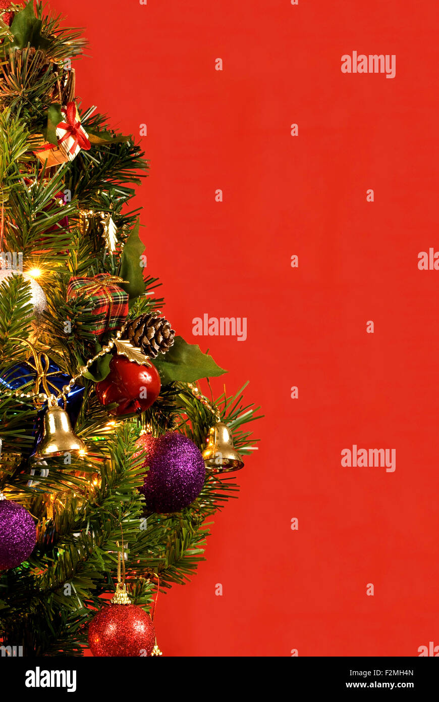 Christmas Tree With Lights And Ornaments On Red Background Vertical ...