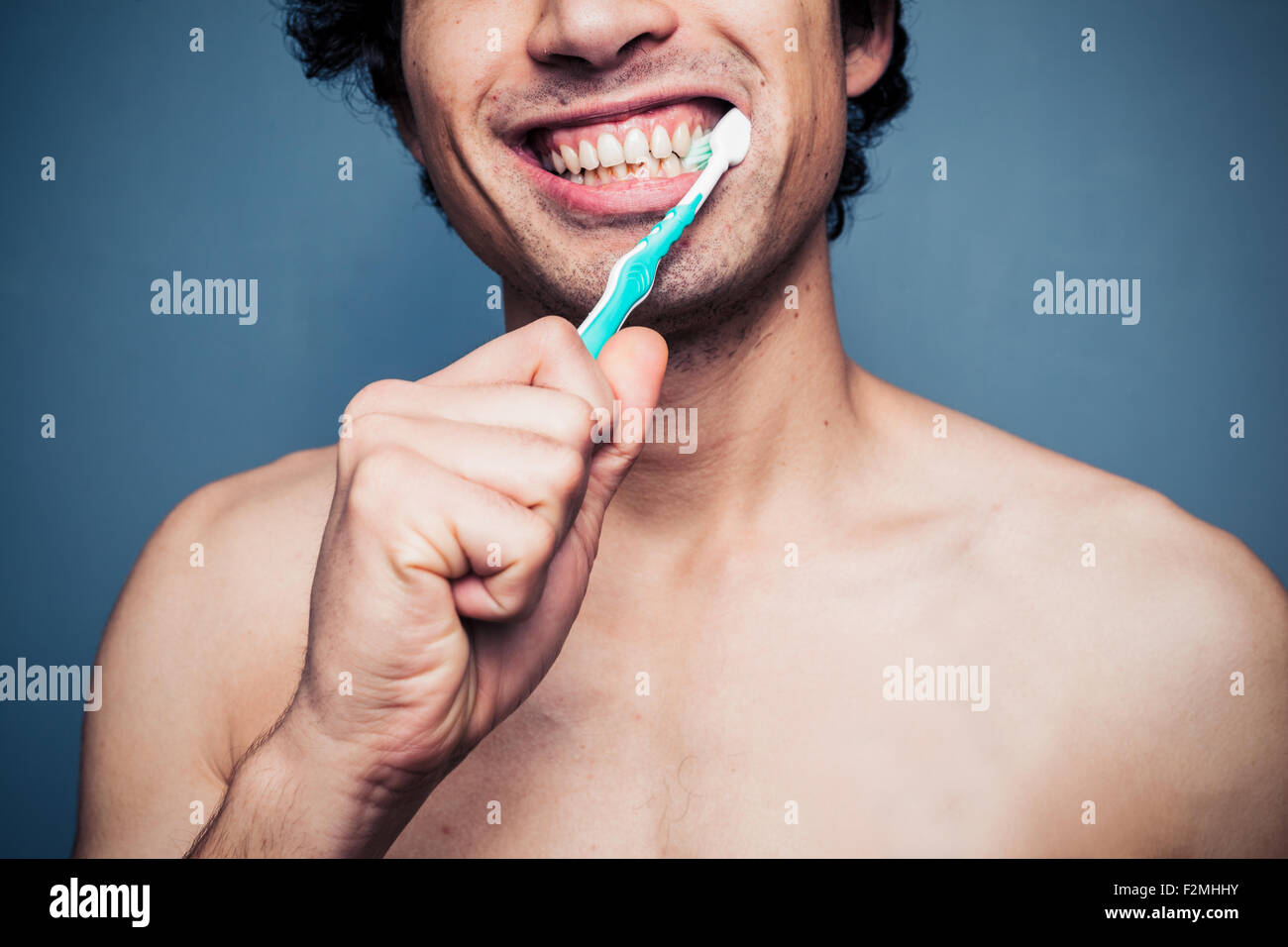 Young man brushing his teeth Stock Photo - Alamy
