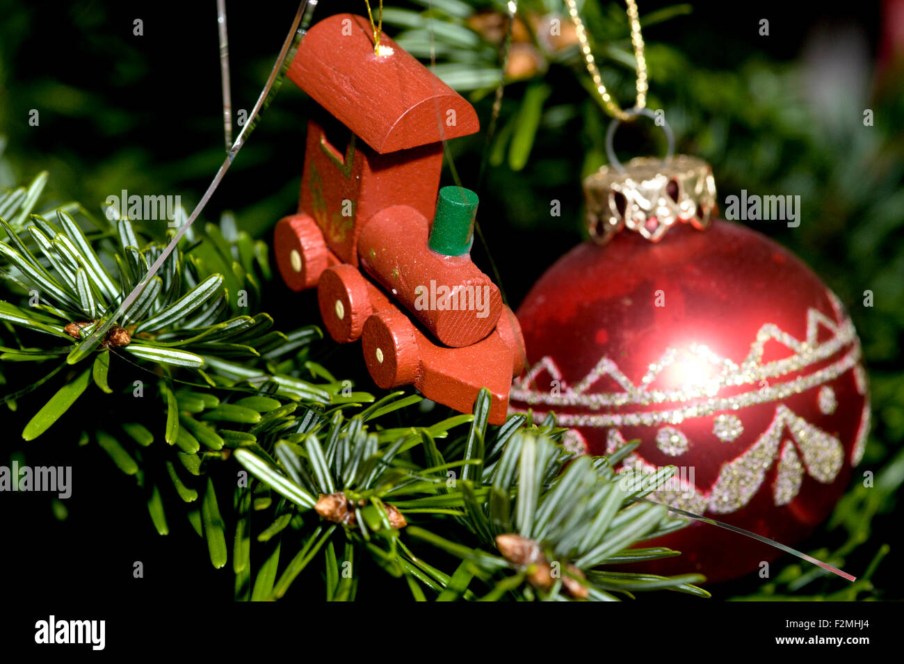 close up detail of a wooden toy steam engine and red and silver ...