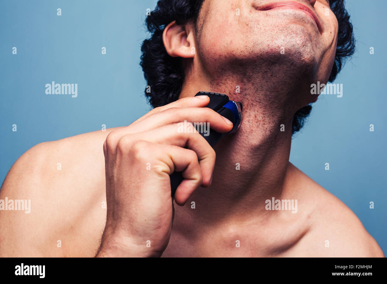 Man shaving with electrical razor Stock Photo - Alamy