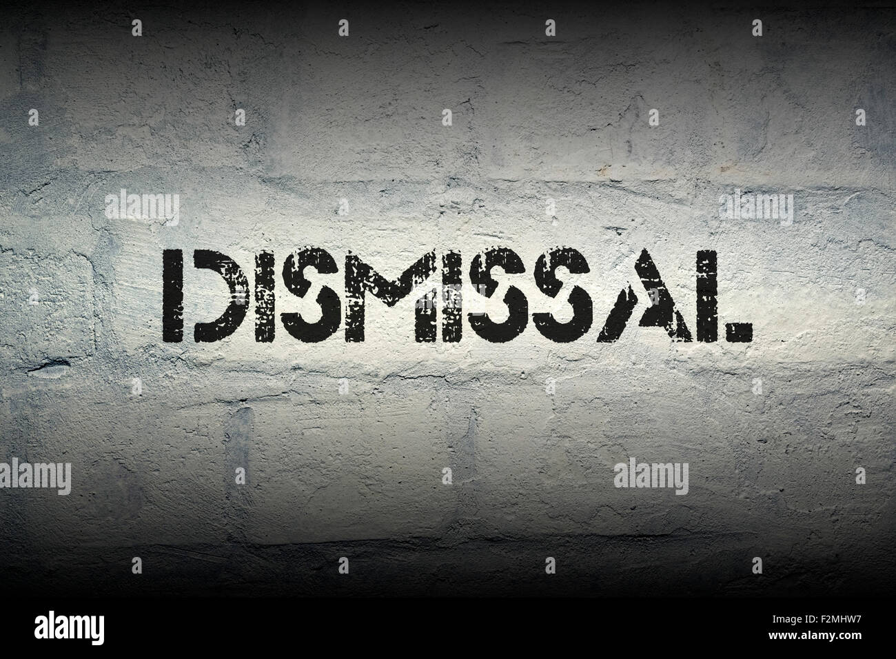dismissal stencil print on the grunge white brick wall Stock Photo - Alamy