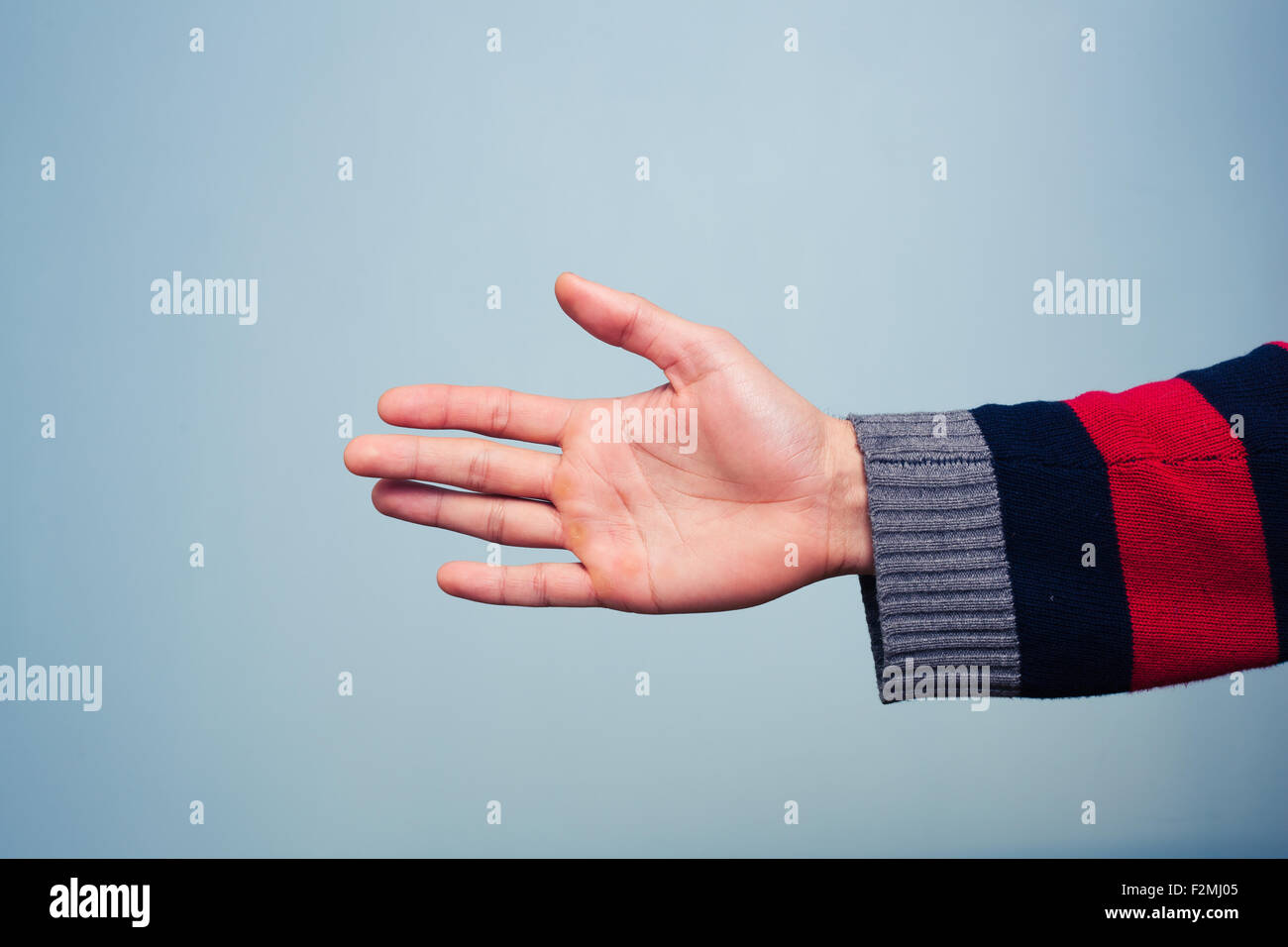 Young man offering handshake Stock Photo - Alamy