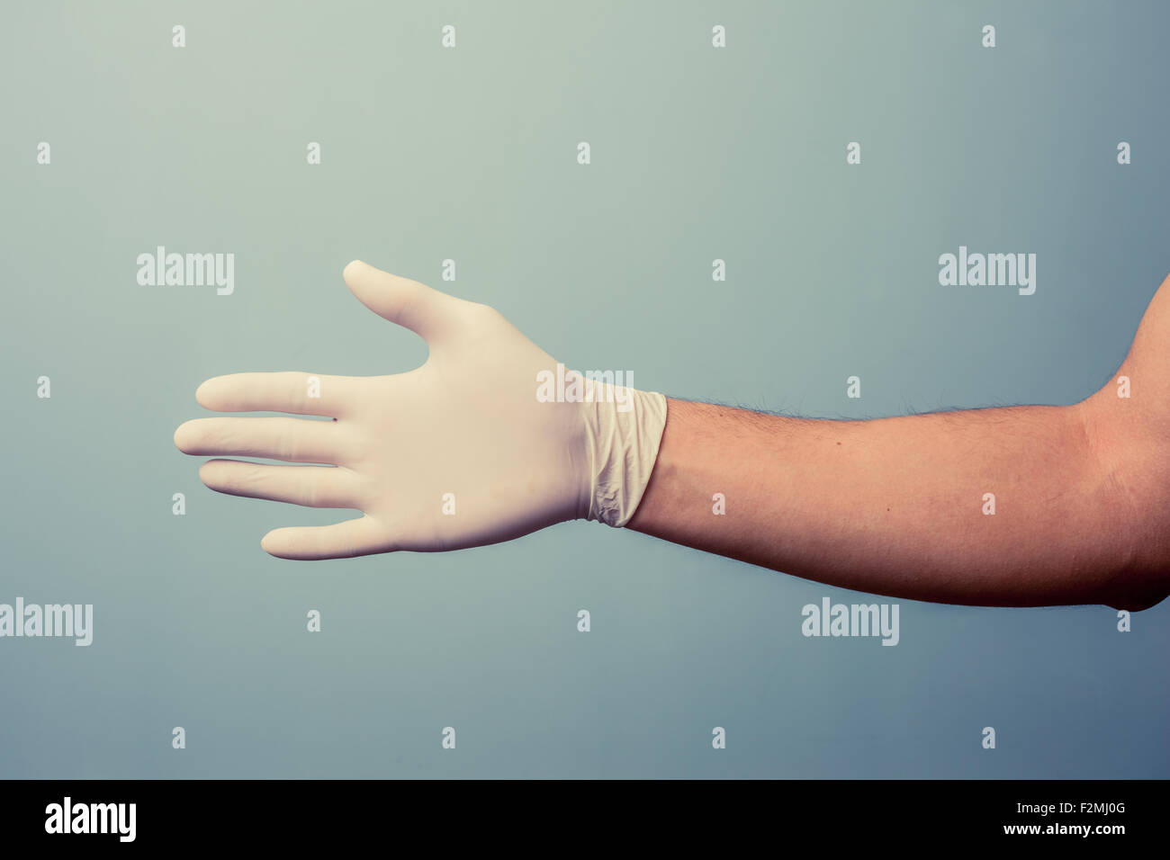 Hand wearing rubber glove hi-res stock photography and images - Alamy