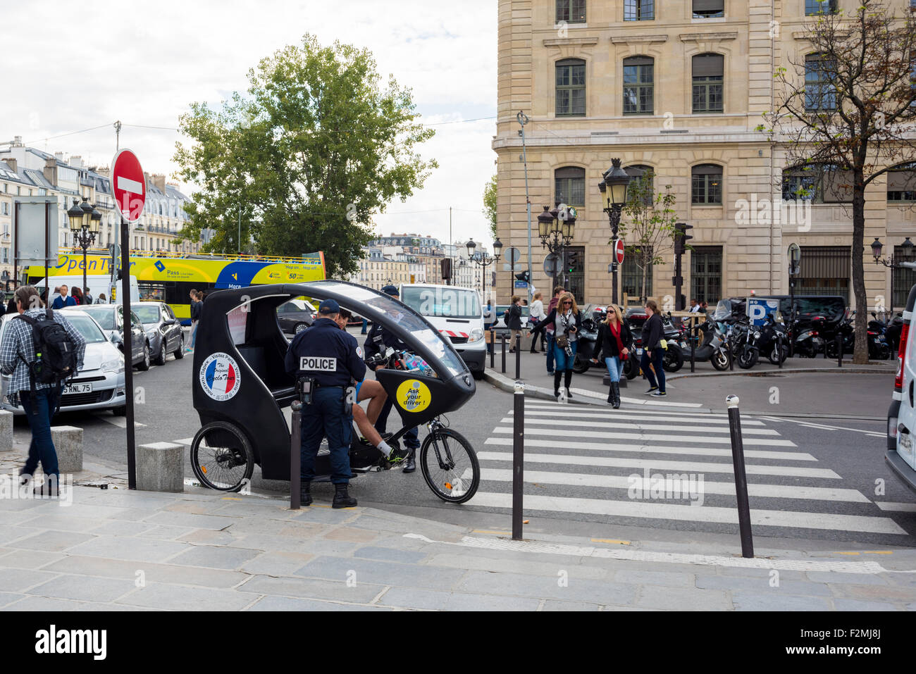 A Bicycle rickshaw owner getting a ticket from French Police the ...