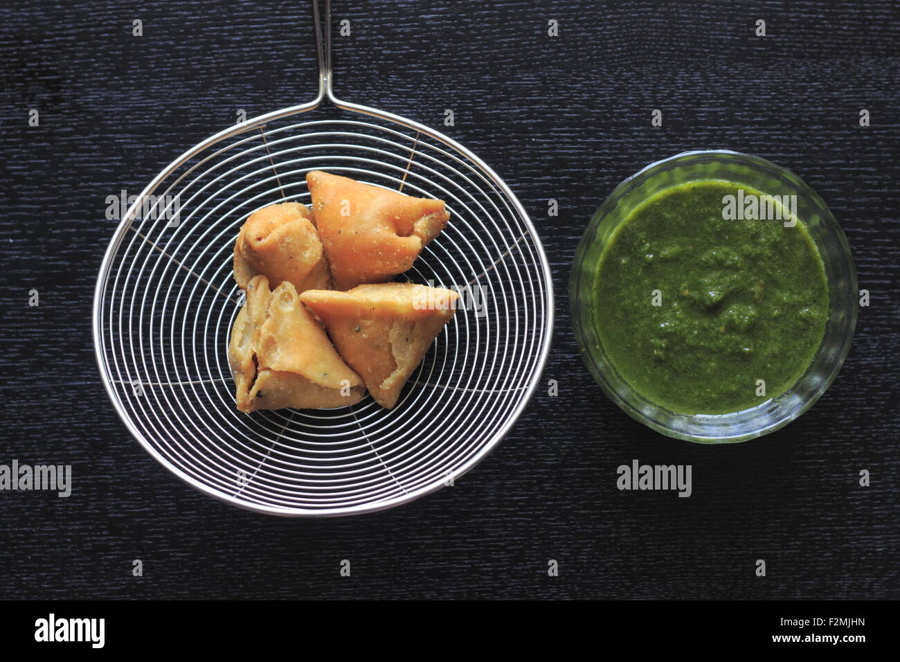 Popular indian, asian and african deep fried snack called samosa with ...