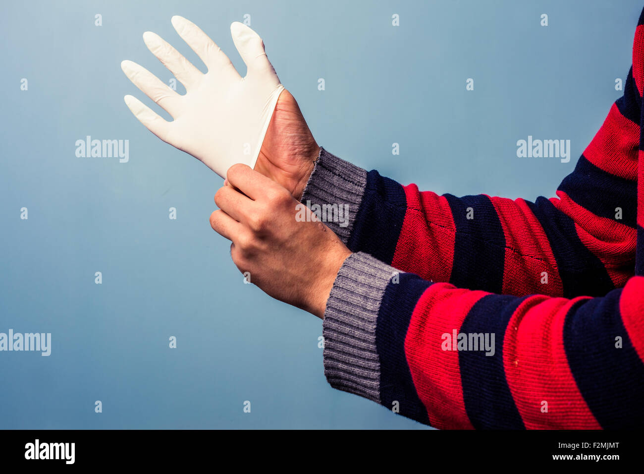 Man putting on latex gloves hi-res stock photography and images - Alamy