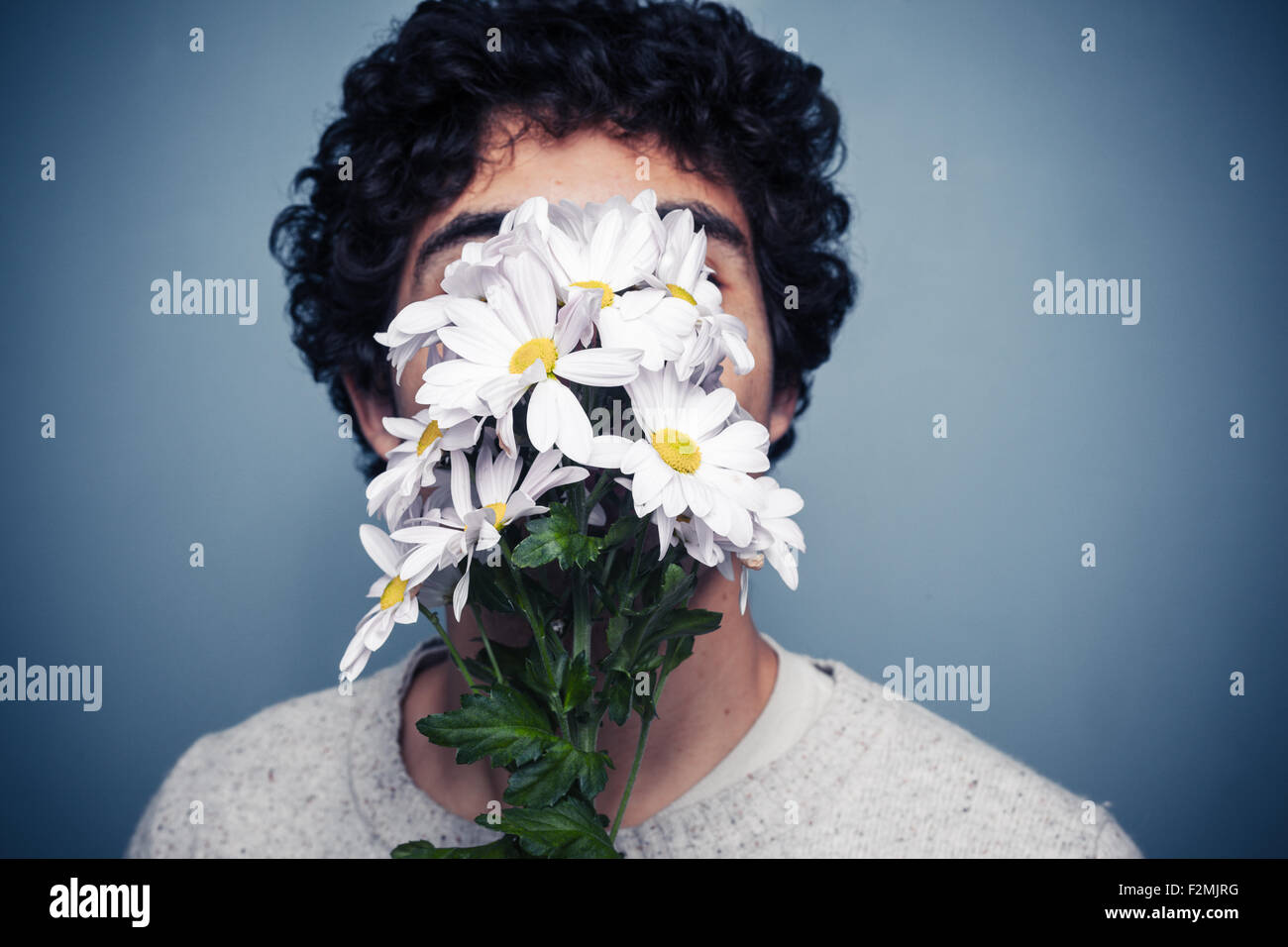 Handsome man hiding gift hi-res stock photography and images - Alamy