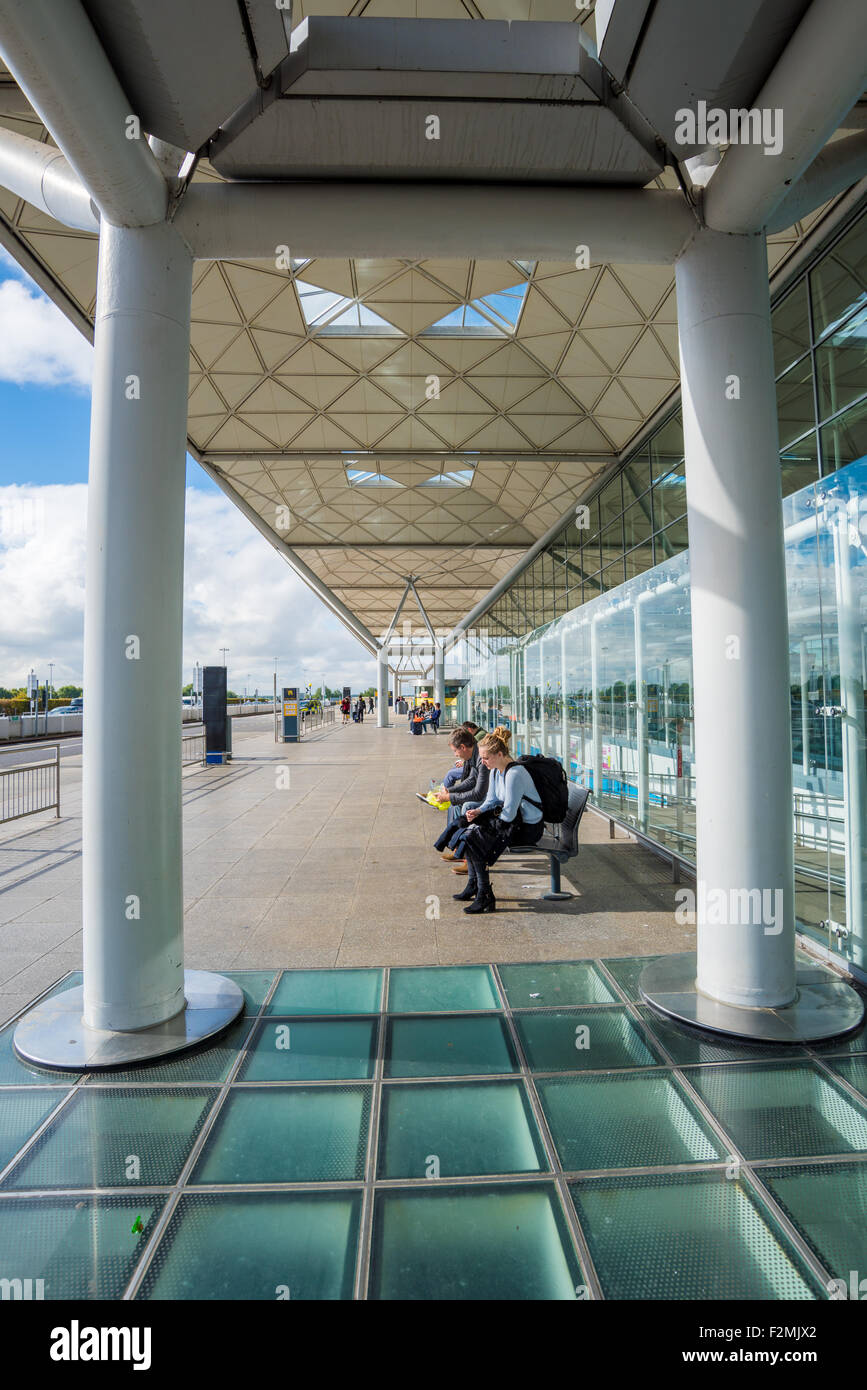 People waiting for the bus at Stansted Airport London UK Stock Photo ...