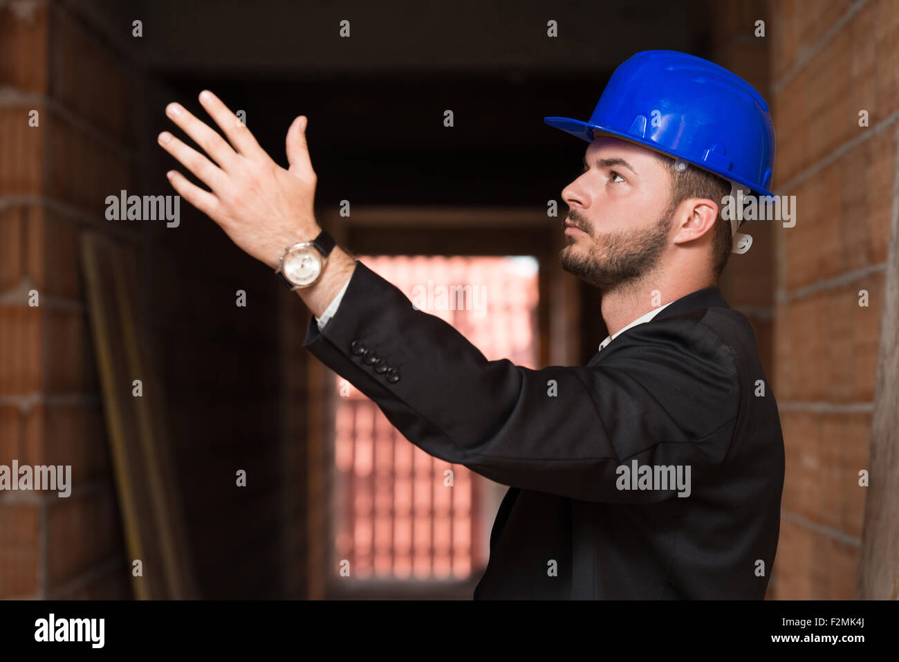 Young Construction Pointing On Ceiling Stock Photo - Alamy