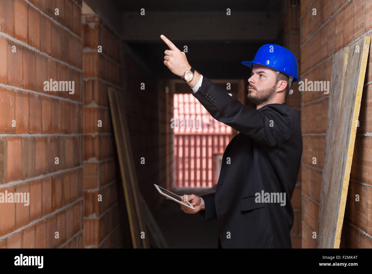 Young Construction Pointing On Ceiling Stock Photo - Alamy