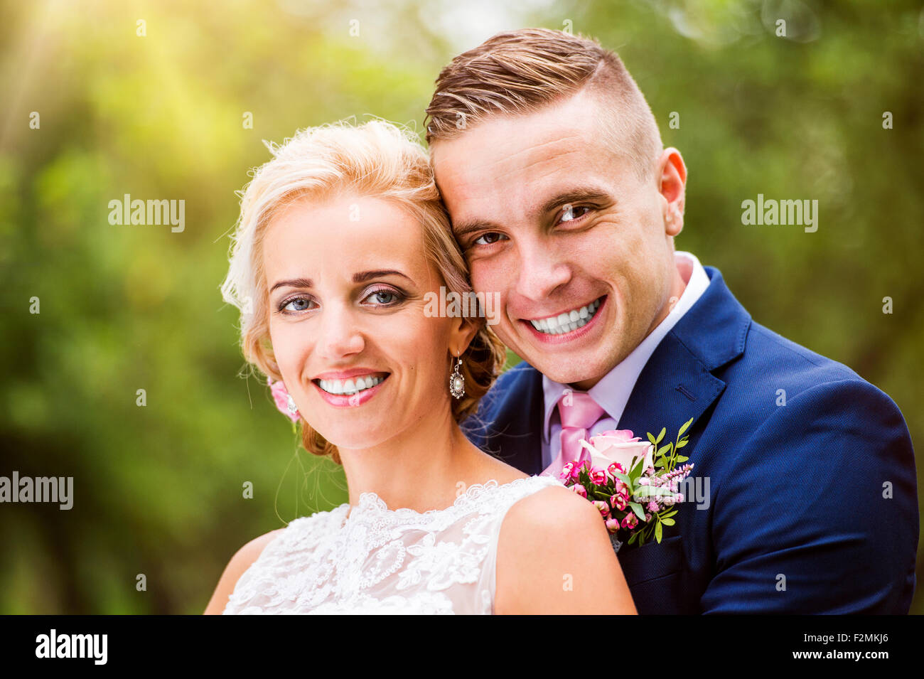 Beautiful young wedding couple outside in nature Stock Photo - Alamy
