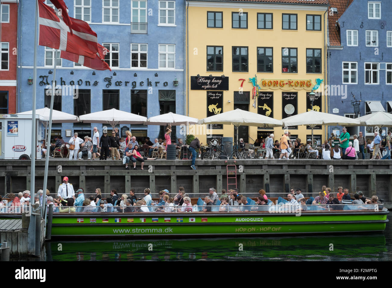 Tourists taking a canal trip at Nyhavn New Harbour Copenhagen Denmark ...