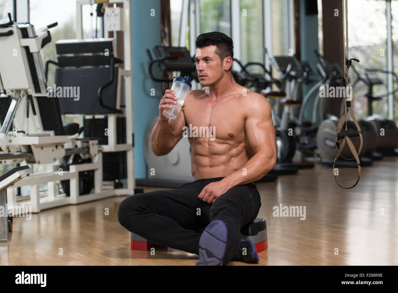 Muscular Man Resting After Exercise And Drinking From Shaker Stock ...
