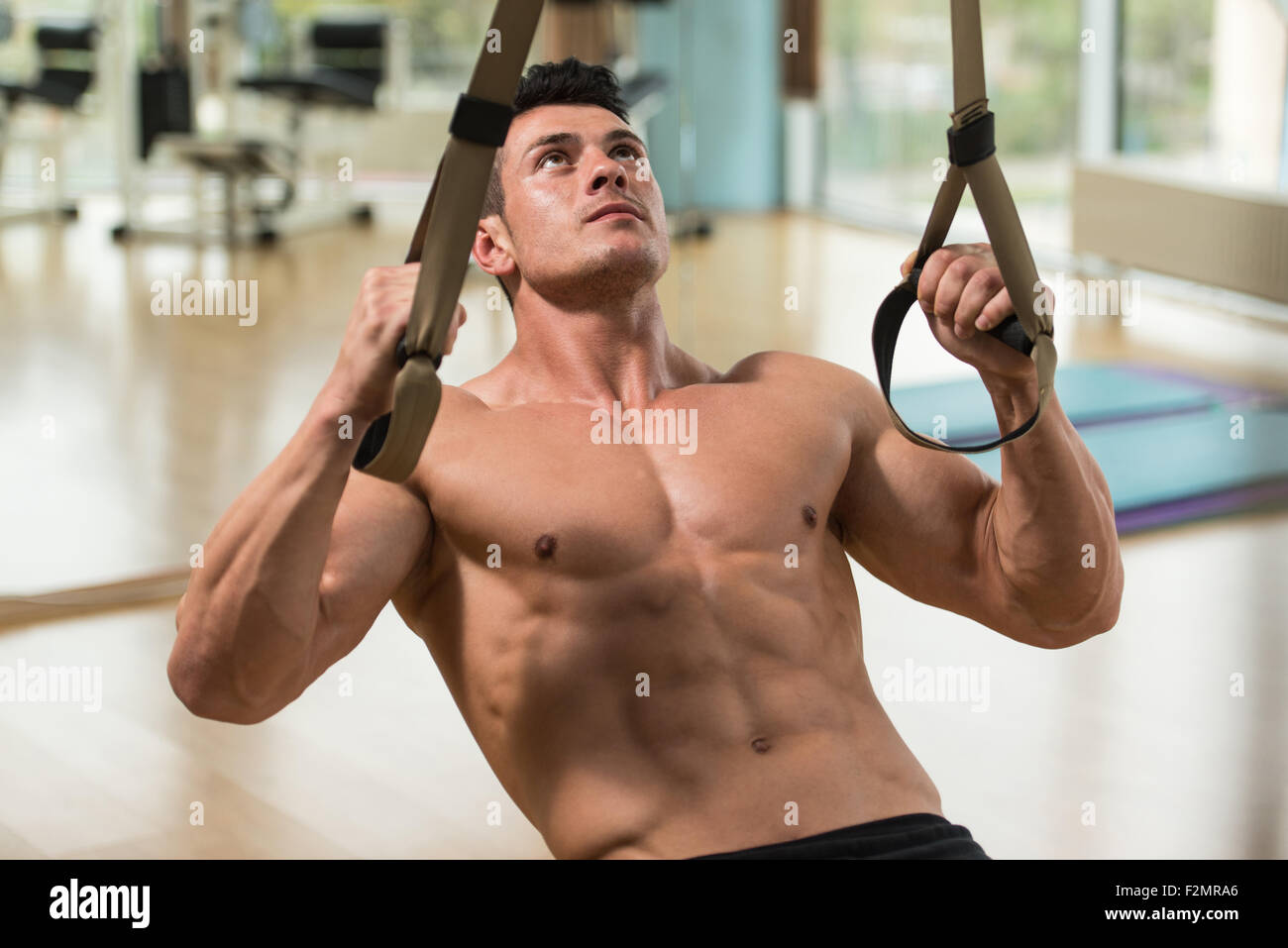 Attractive Man Does Crossfit Push Ups With Trx Fitness Straps In The ...