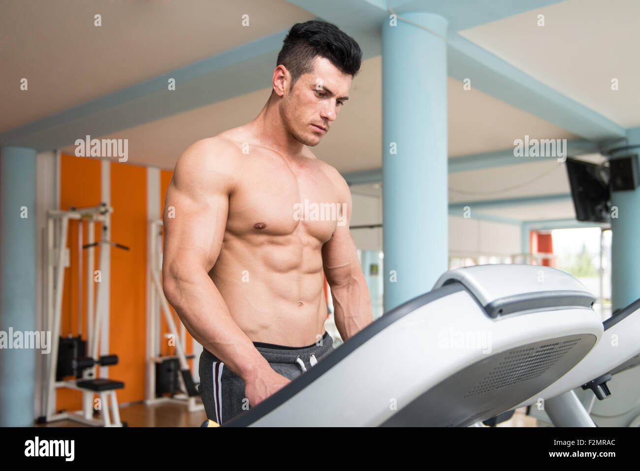 Handsome Man Running On The Treadmill In Gym Stock Photo - Alamy