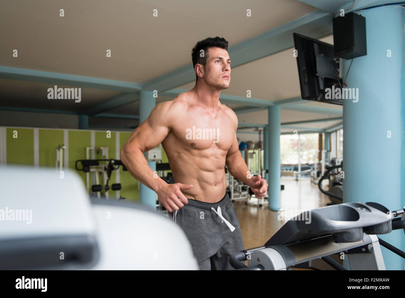Handsome Man Running On The Treadmill In Gym Stock Photo - Alamy