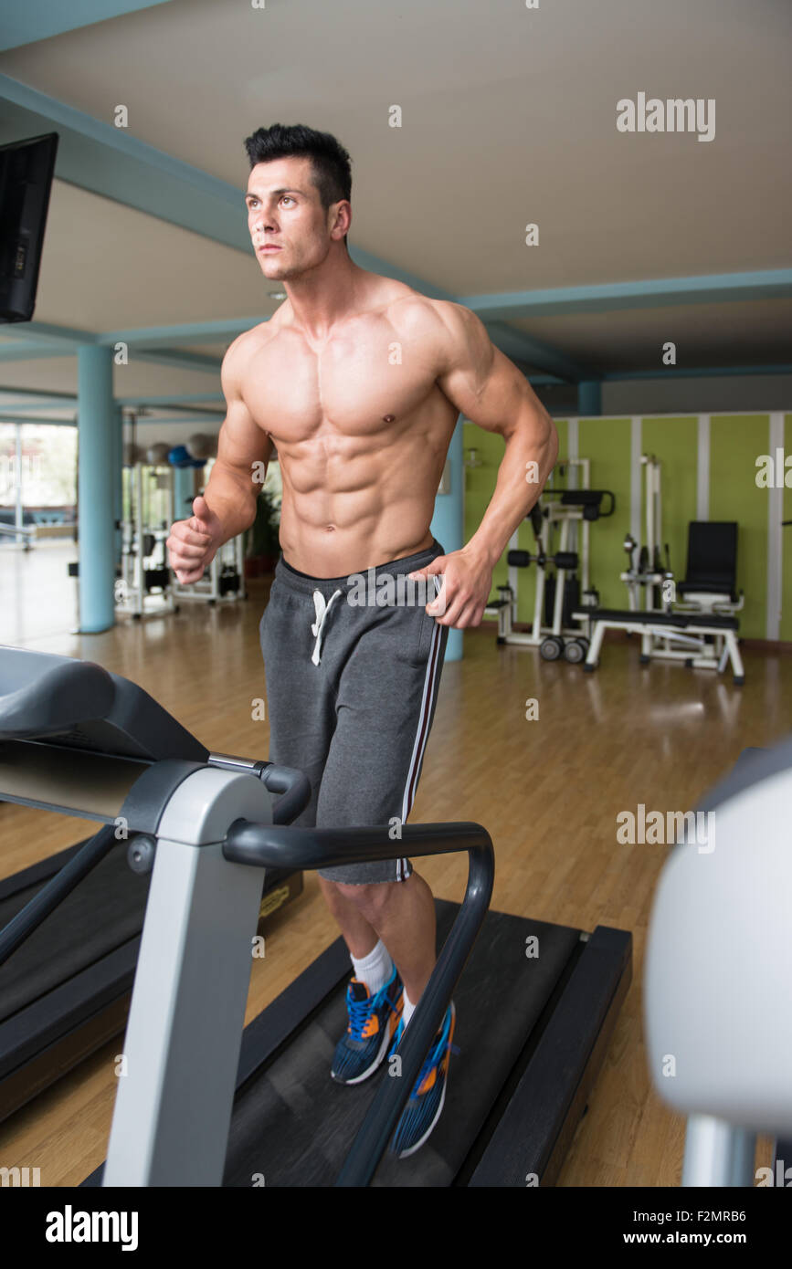 Handsome Man Running On The Treadmill In Gym Stock Photo - Alamy