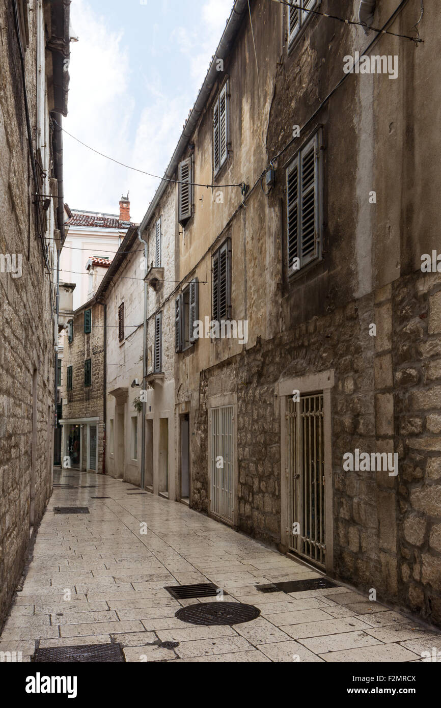 Small and empty alley or pedestrian street at the old town in Split ...