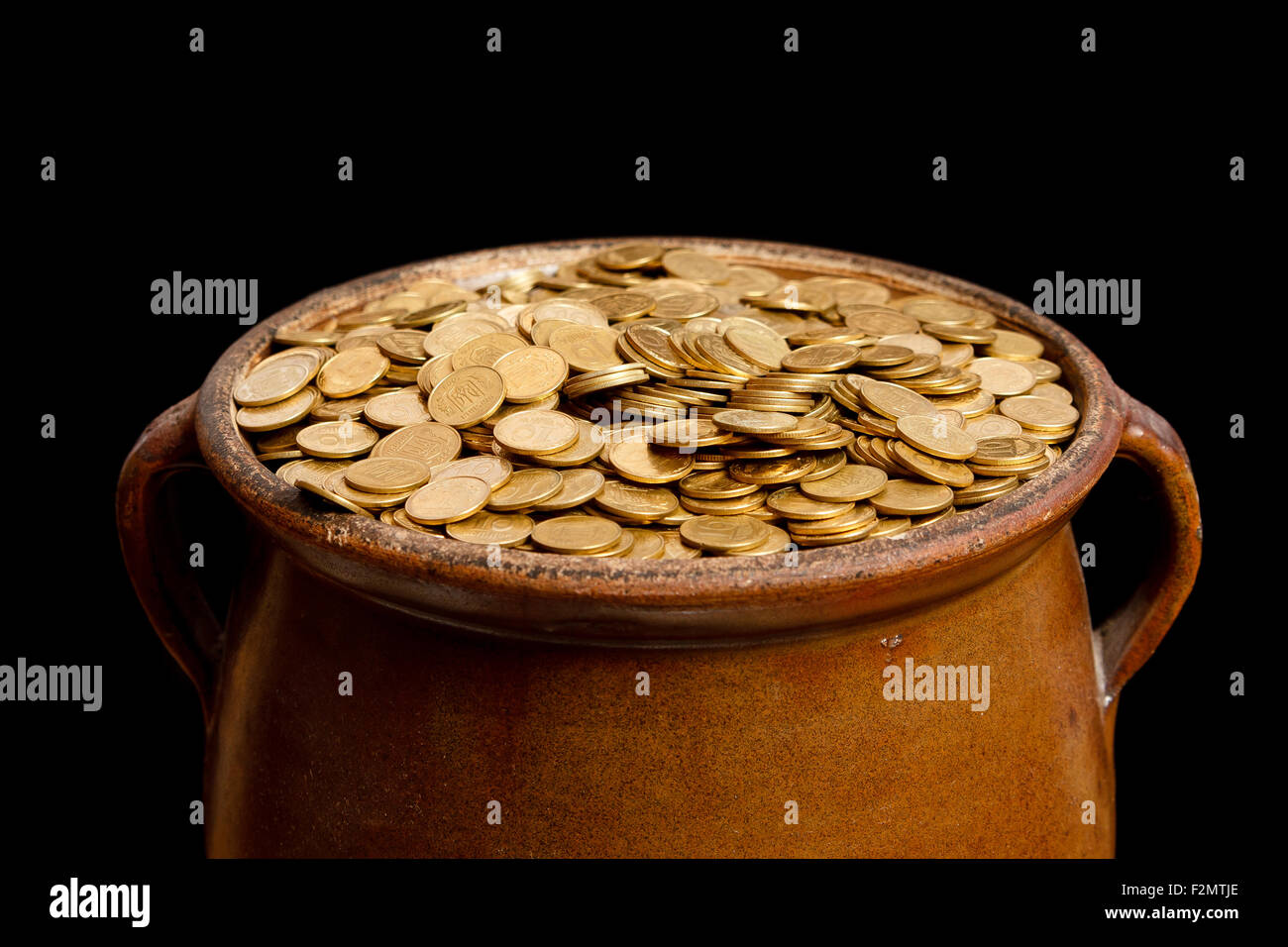 Golden coins in black hi-res stock photography and images - Alamy