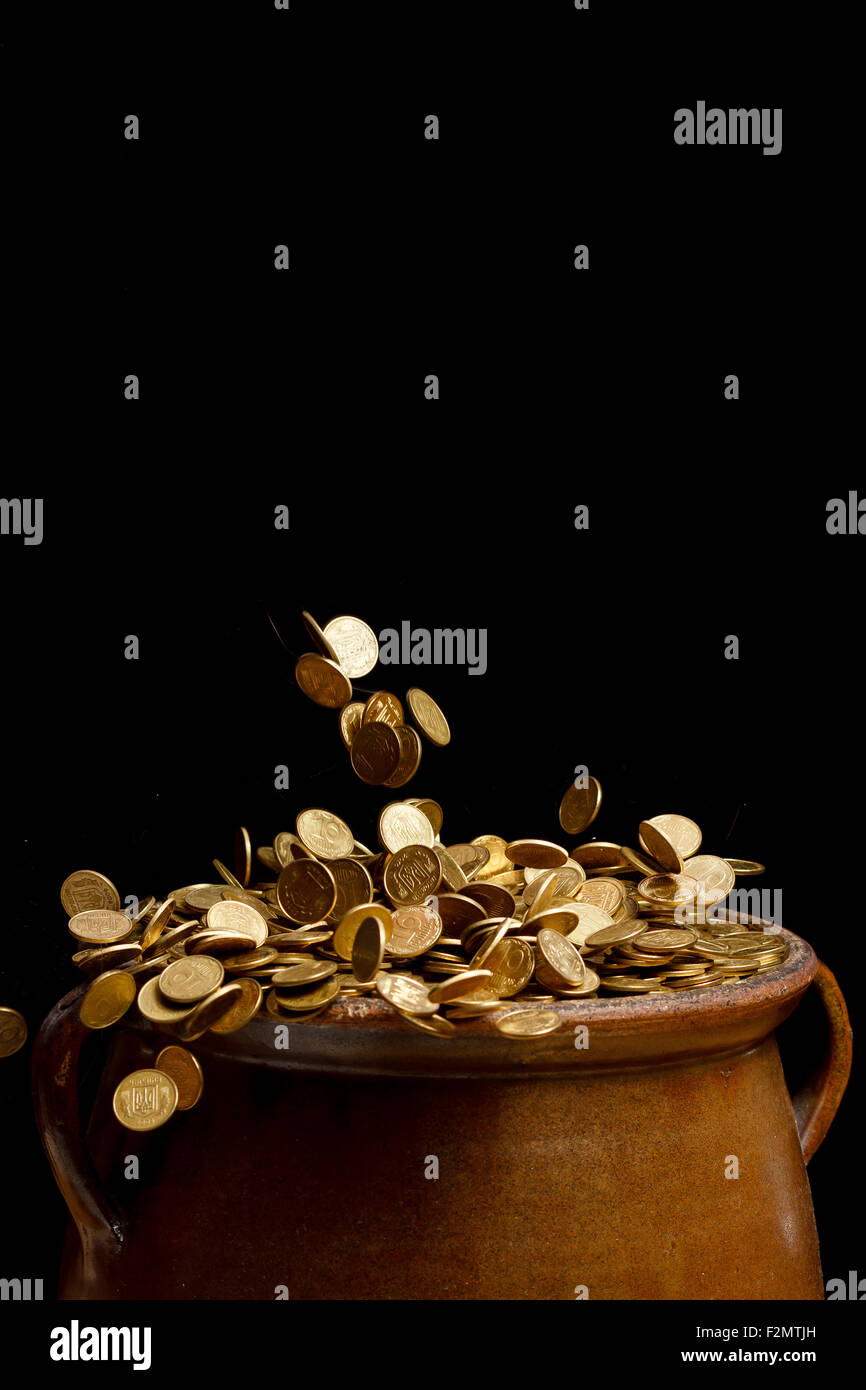 Dollar coins falling pot hi-res stock photography and images - Alamy