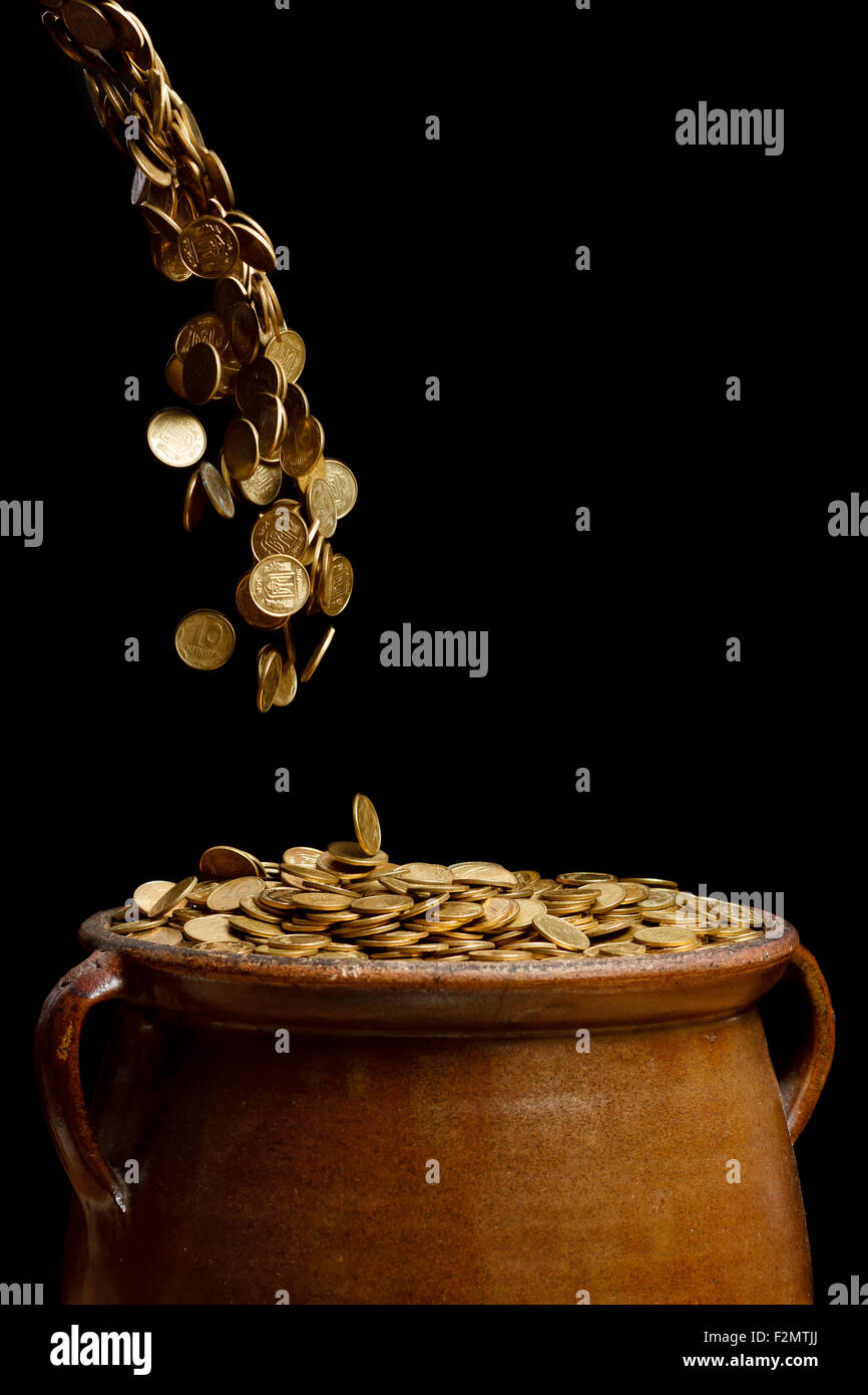 gold coins falling in the vintage pot Stock Photo - Alamy