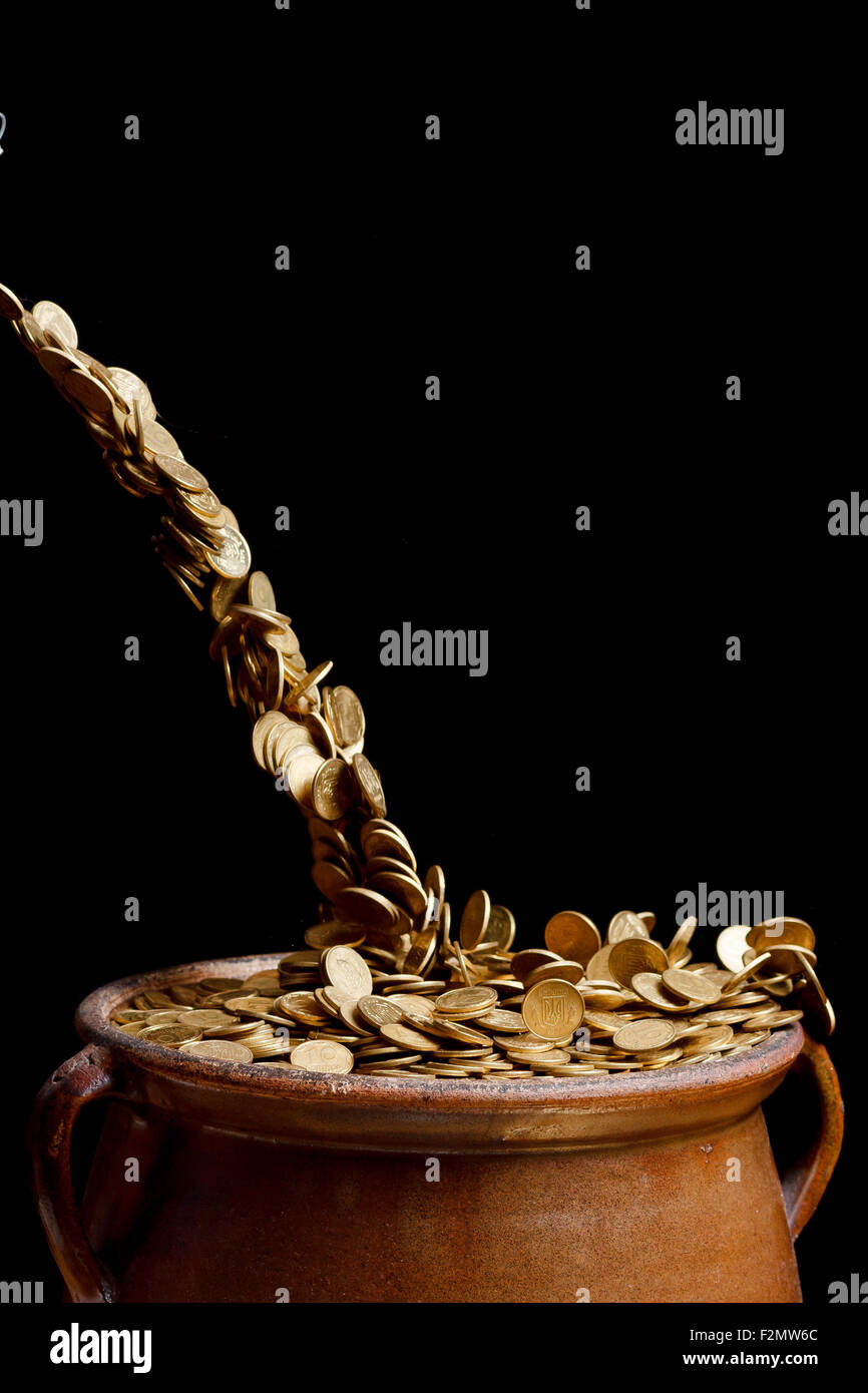 gold coins falling in the vintage pot Stock Photo - Alamy