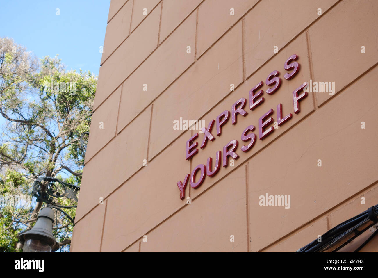 Express Yourself writen in ceramic letters on wall in Soho district of ...