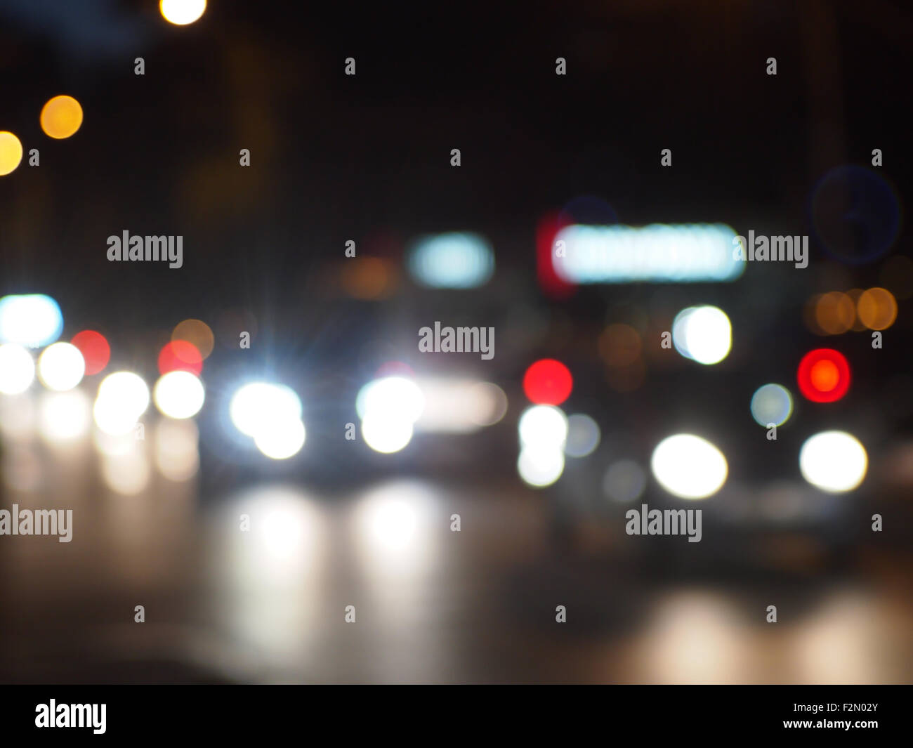 Abstract night scene in the city on the road. Defocused lights on the ...