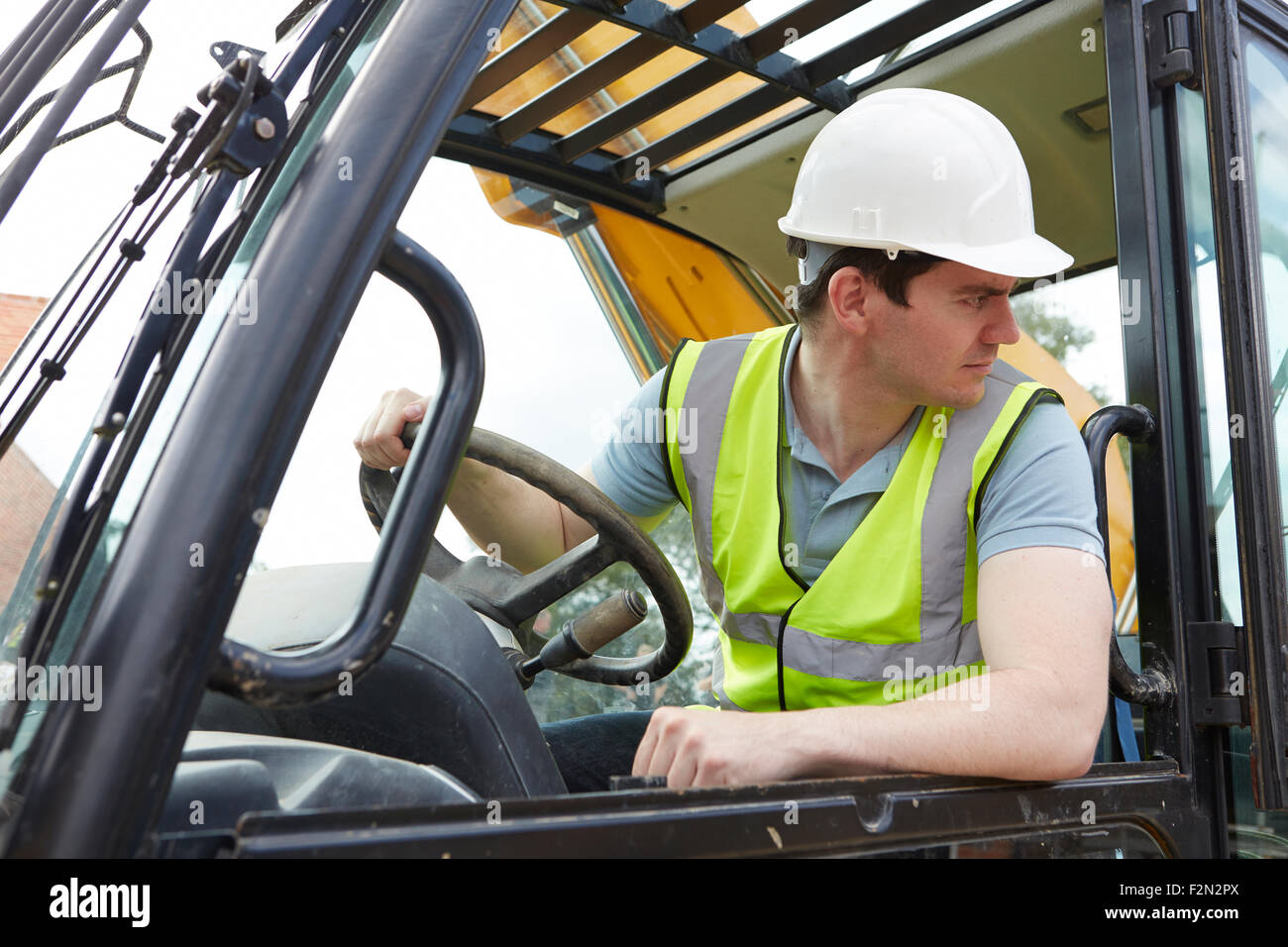 Construction Worker Driving Digger Stock Photo - Alamy