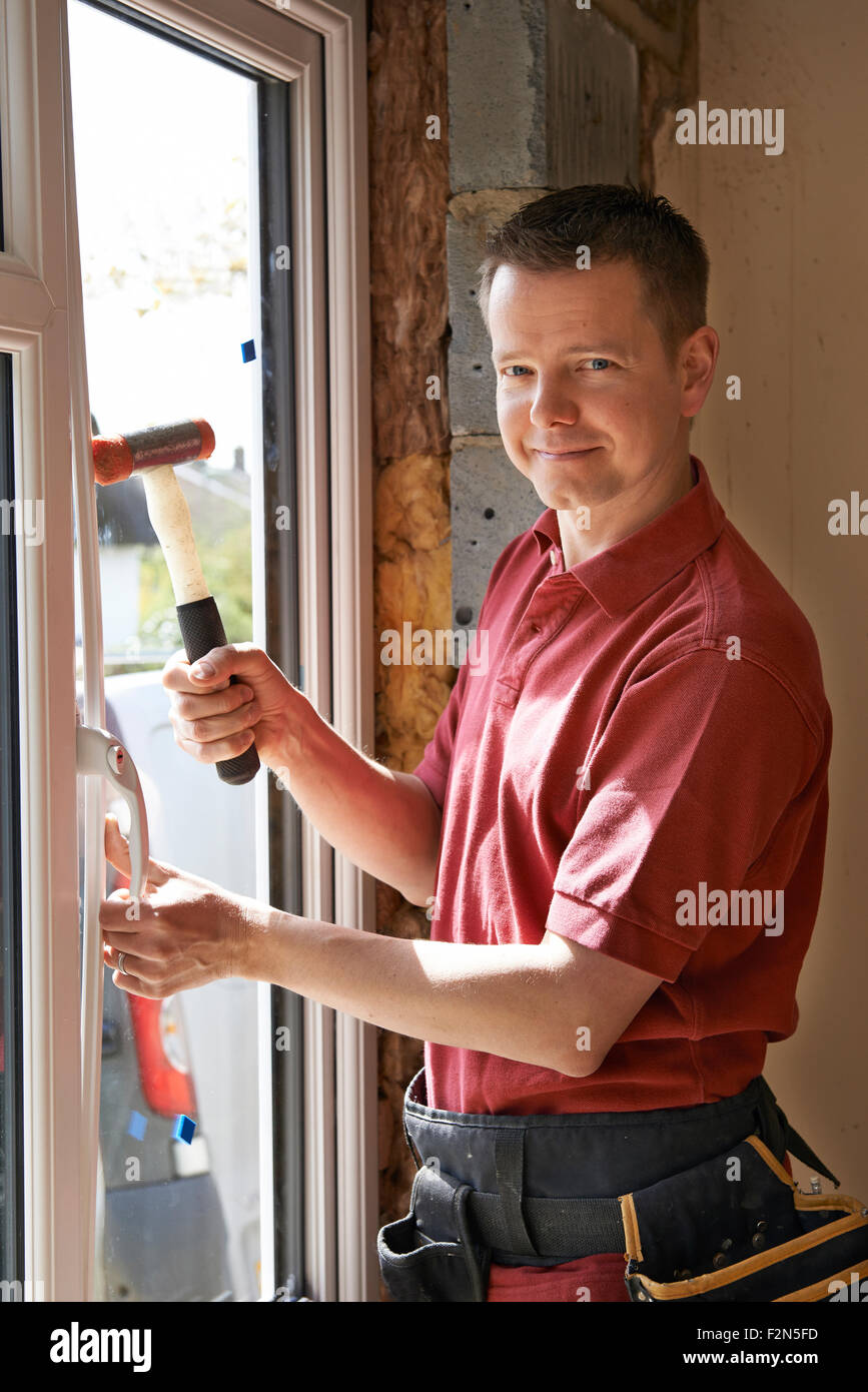 Construction Worker Installing New Windows In House Stock Photo - Alamy