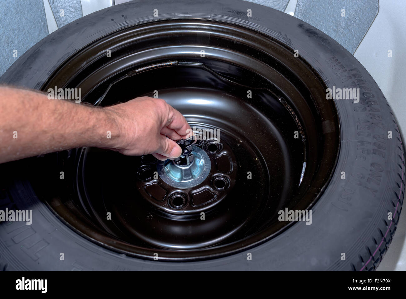 Removing spare tire from a vehicle Stock Photo - Alamy