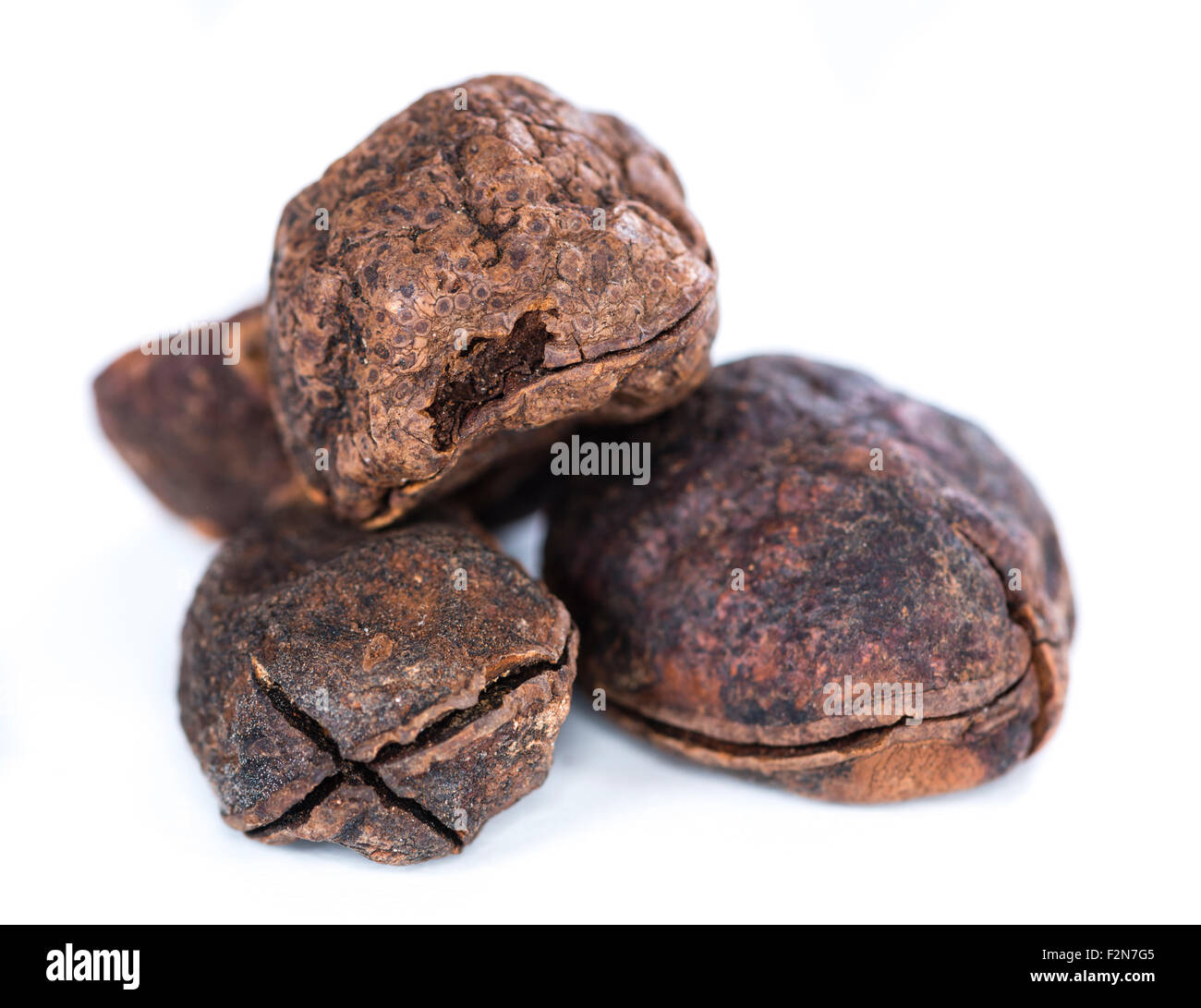 Whole dried Cola Nuts (close-up shot) isolated on white background ...