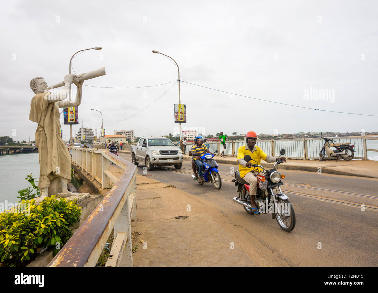 Benin, West Africa, Cotonou, motos and cars passing on the bridge over ...