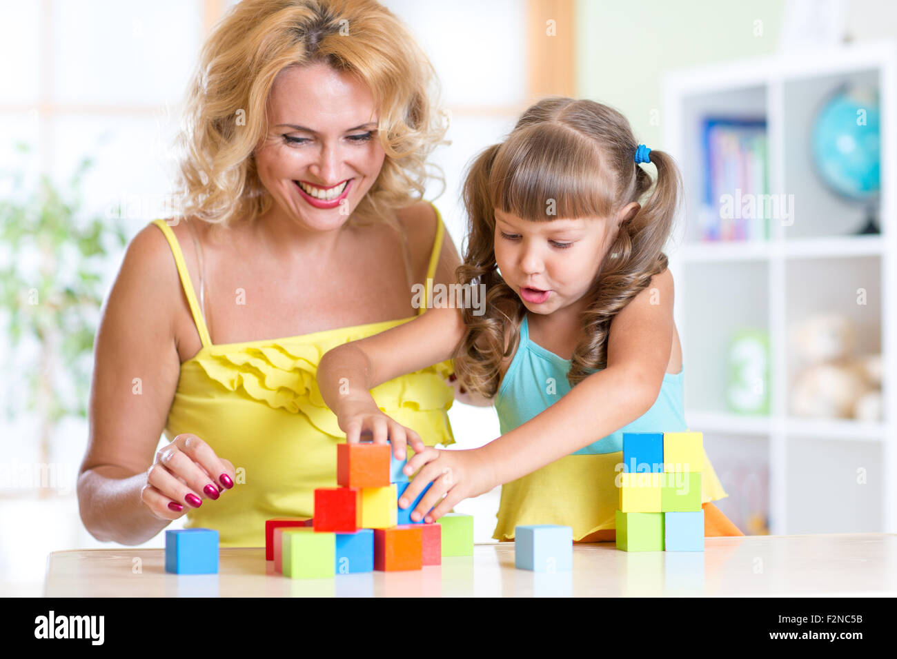 Family mother and daughter playing color bricks Stock Photo - Alamy