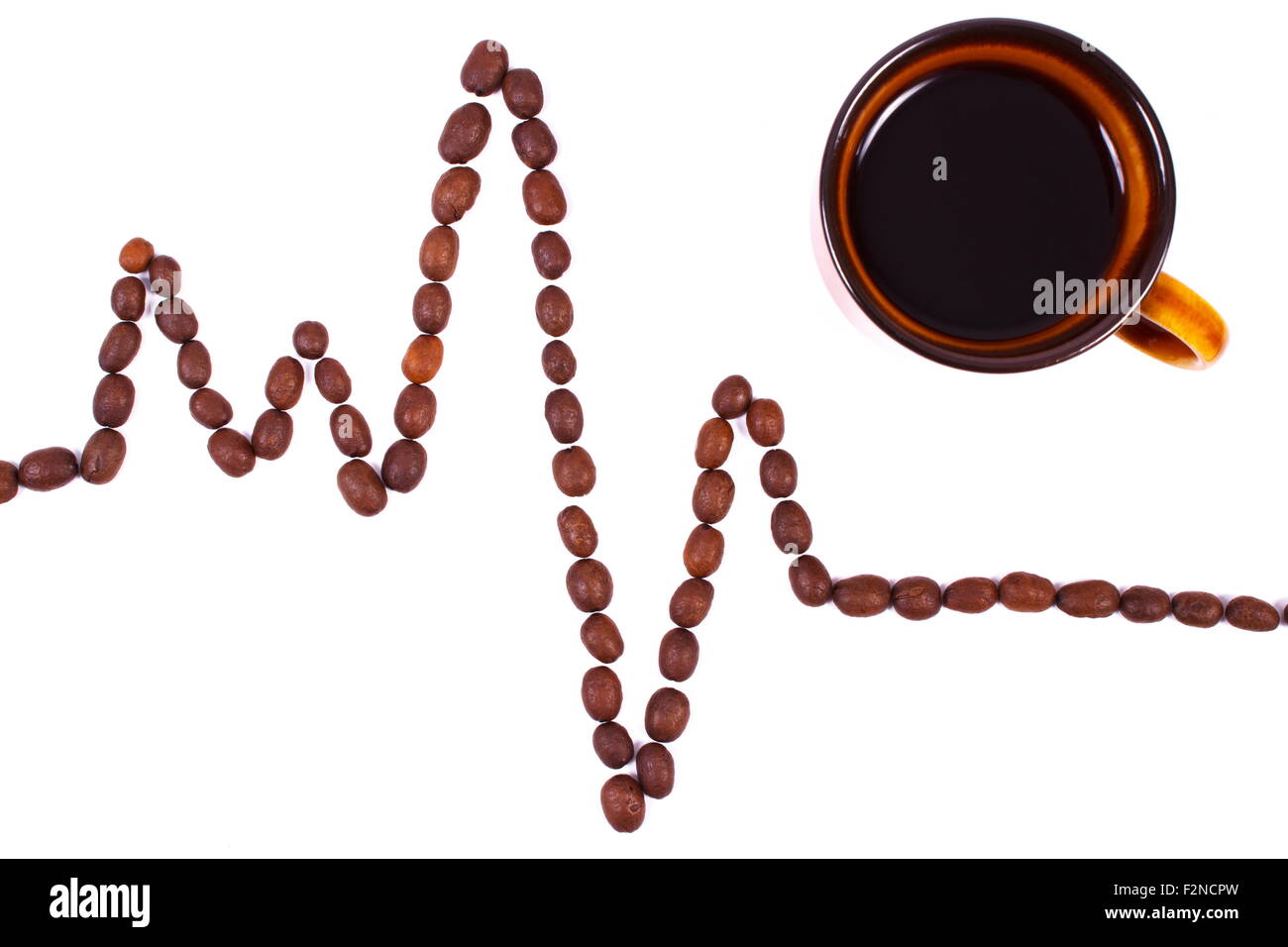 Electrocardiogram line of roasted coffee grains and cup of coffee on ...