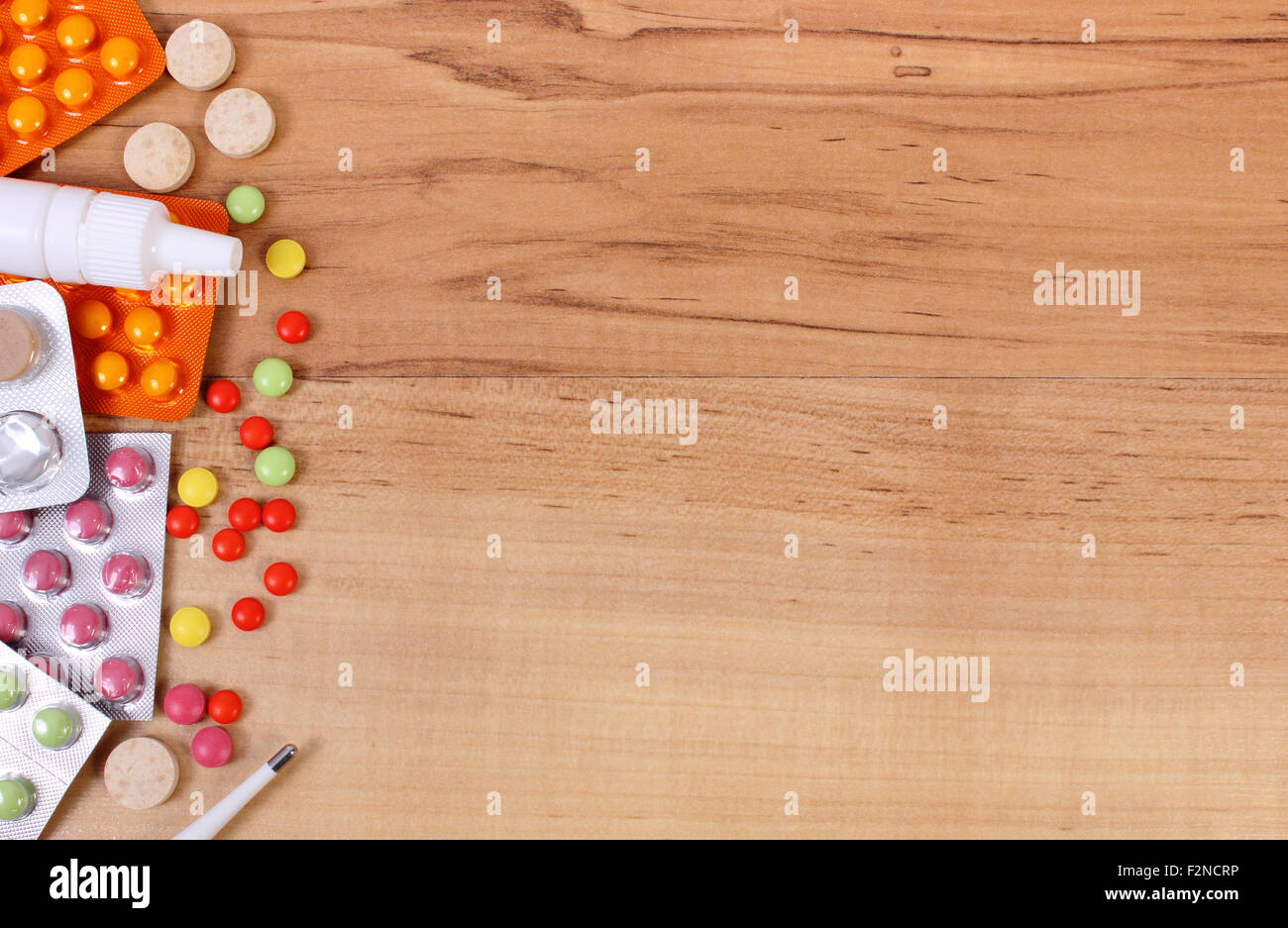 Medication for treatment of colds, flu and runny on wooden background ...