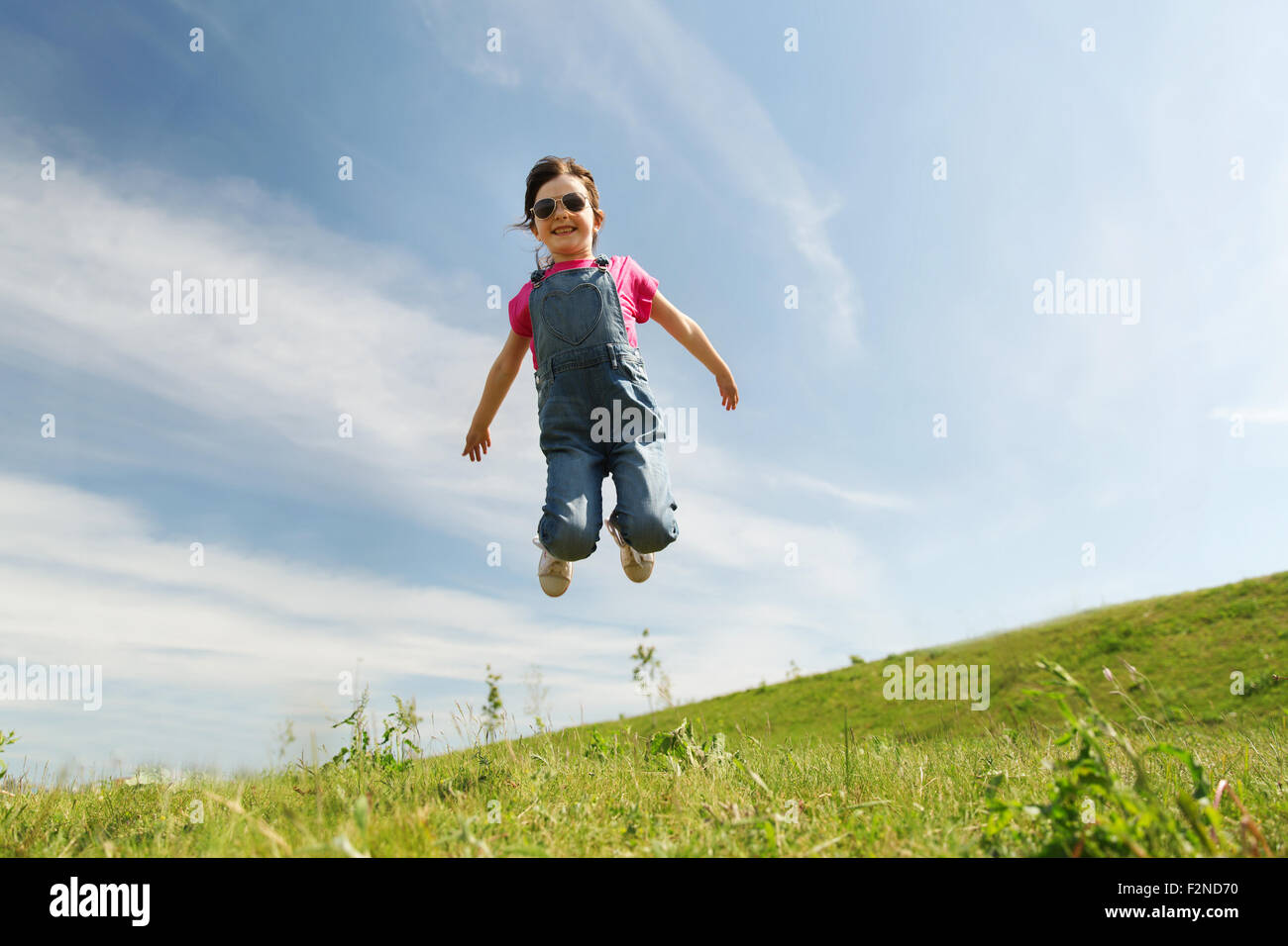 happy little girl jumping high outdoors Stock Photo - Alamy