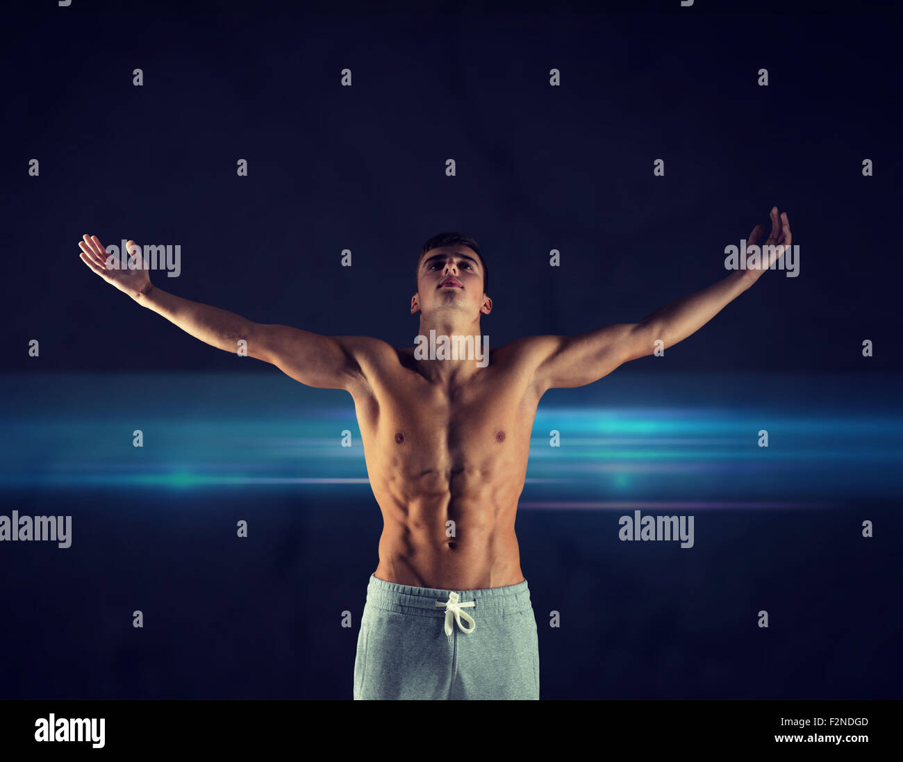 young male bodybuilder with raised hands Stock Photo - Alamy