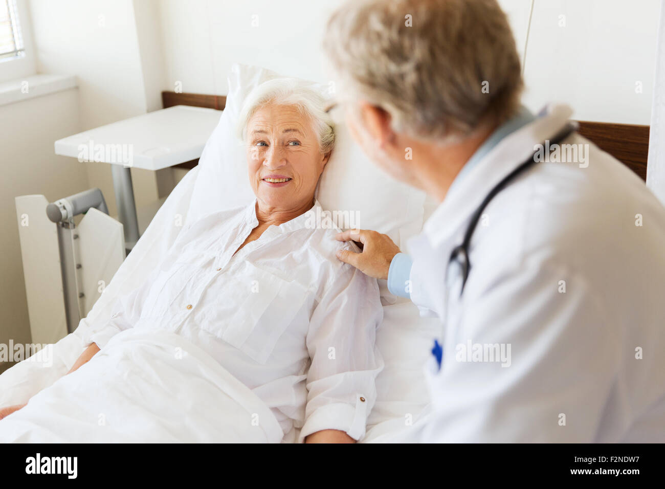 doctor visiting senior woman at hospital ward Stock Photo - Alamy