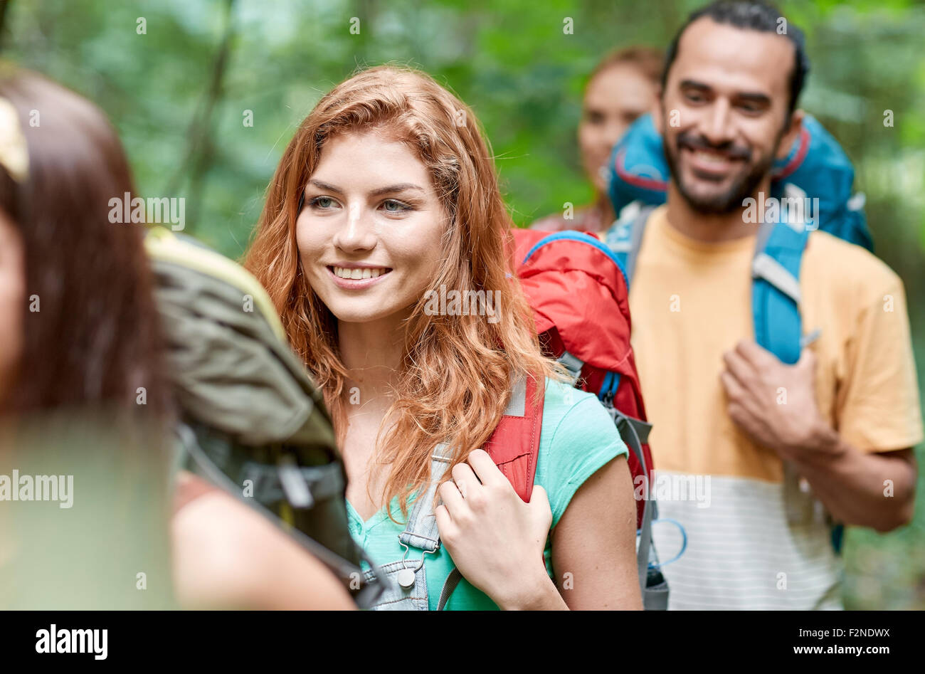 group of smiling friends with backpacks hiking Stock Photo - Alamy
