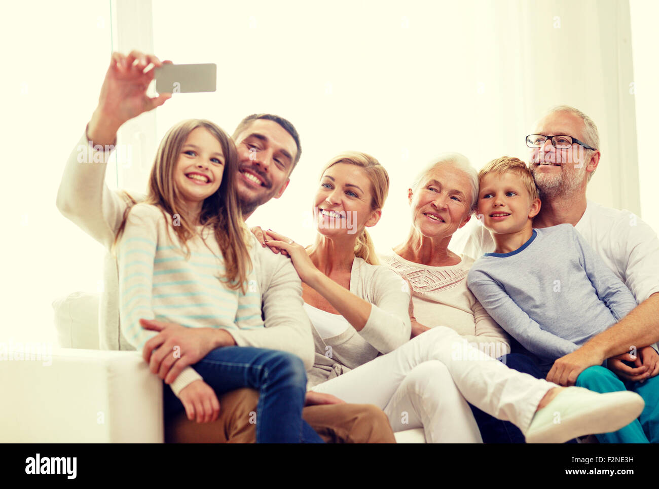 happy family with smartphone at home Stock Photo - Alamy