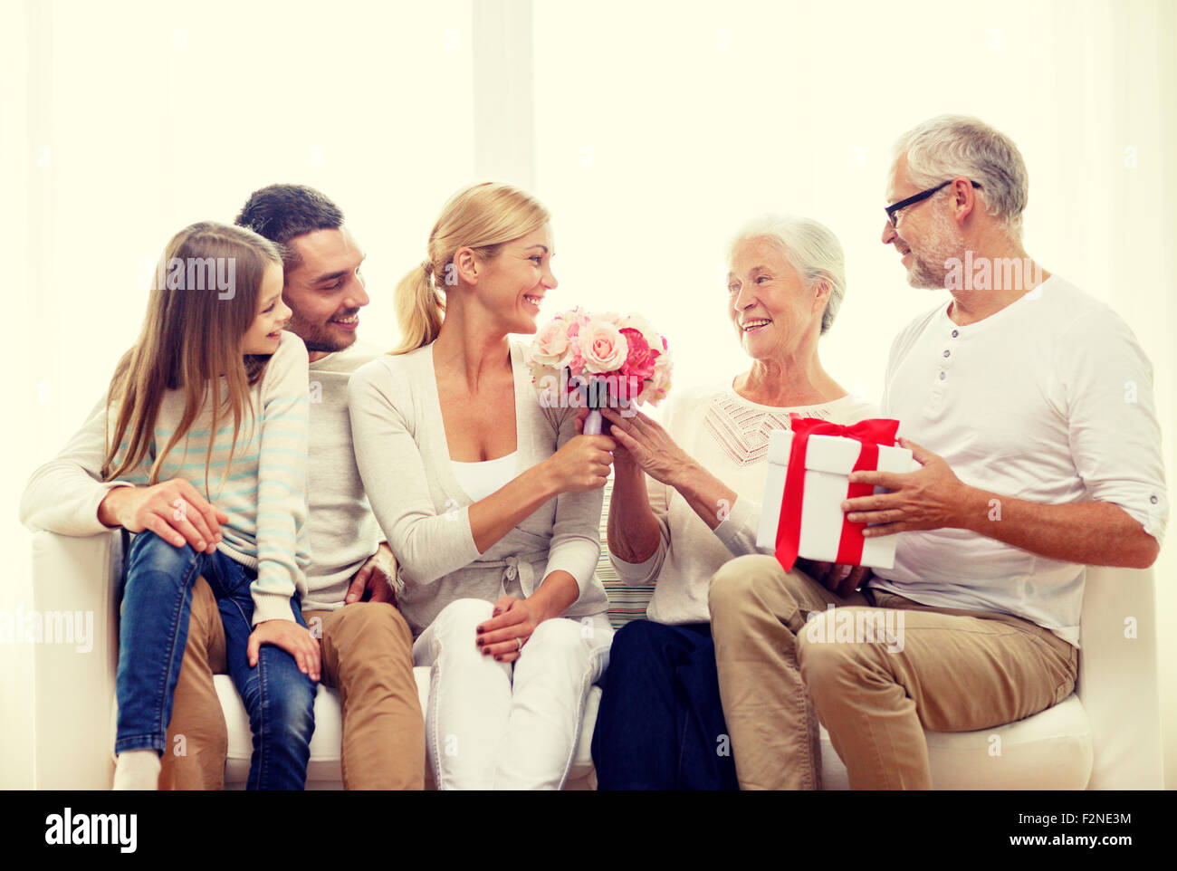 happy family with bunch and gift box at home Stock Photo - Alamy