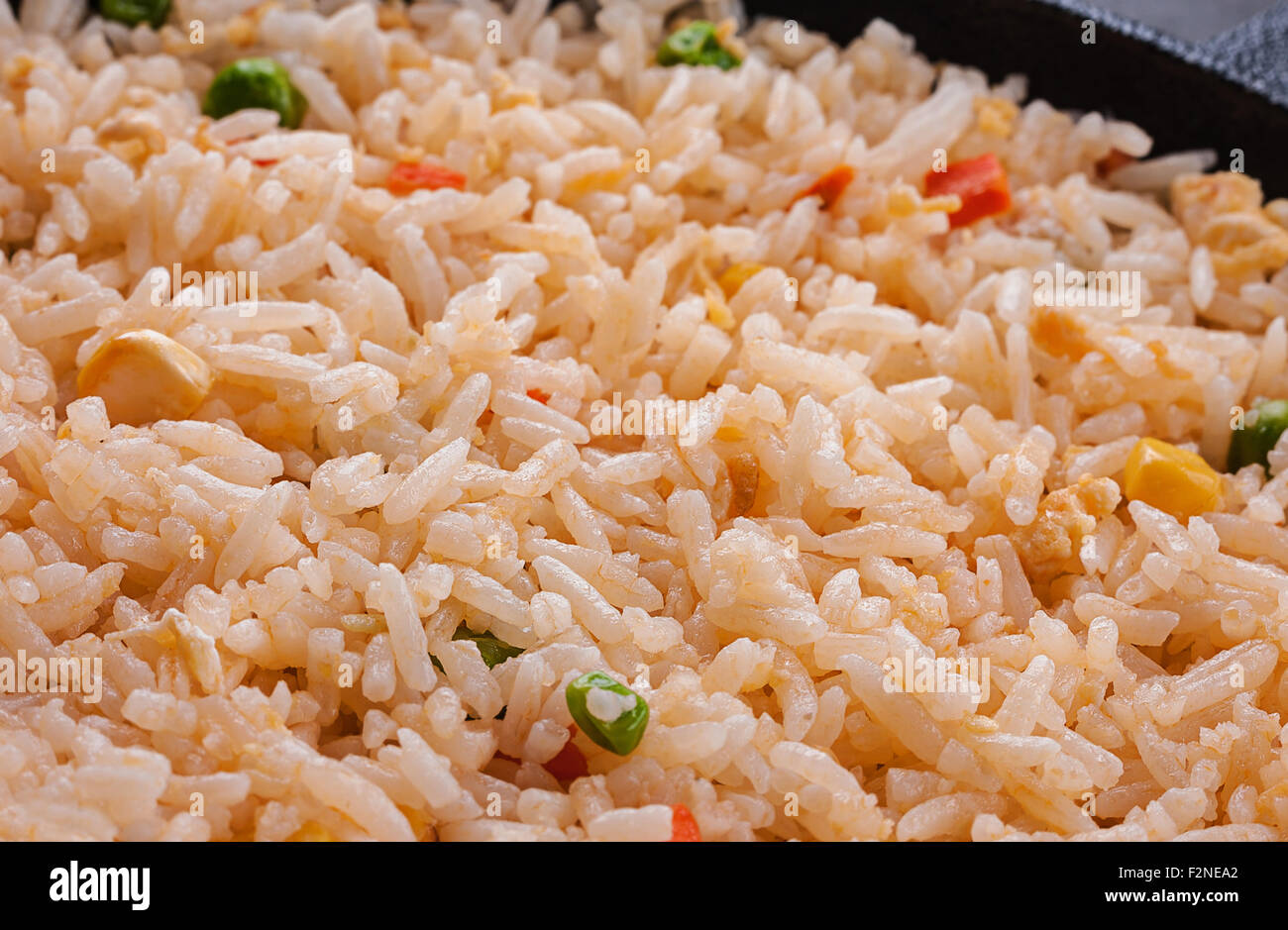 Rice with vegetable in black plate Stock Photo - Alamy