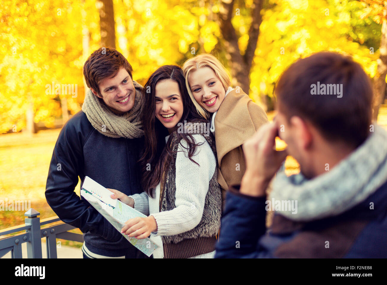 group of friends with map outdoors Stock Photo - Alamy
