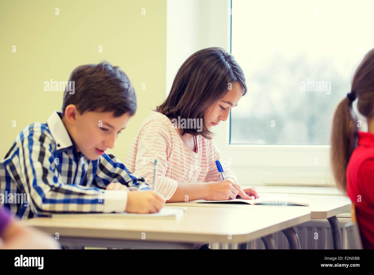 group of school kids writing test in classroom Stock Photo - Alamy