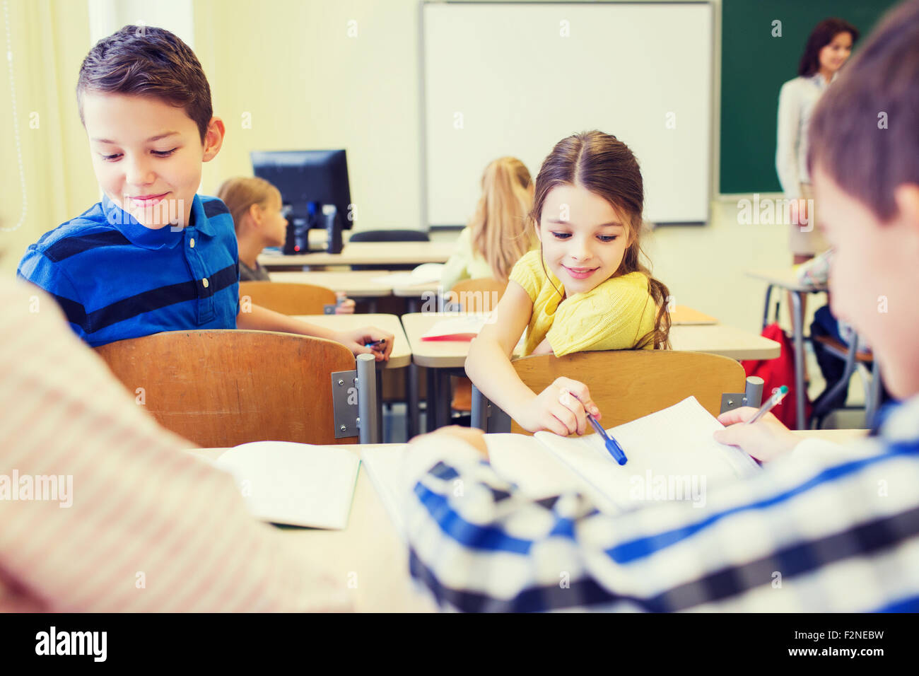 group of school kids writing test in classroom Stock Photo - Alamy