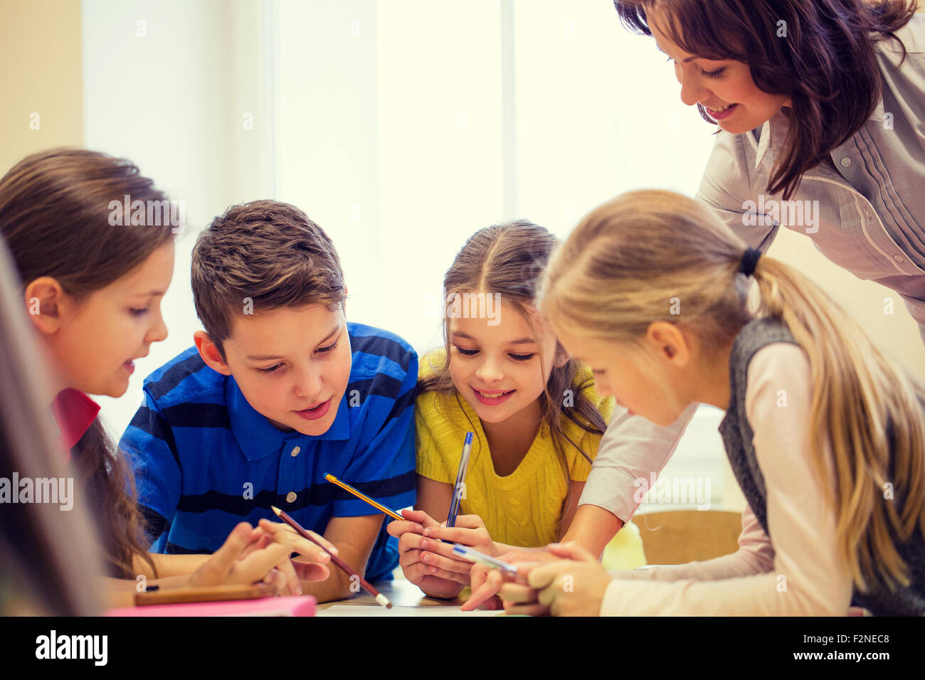 group of school kids writing test in classroom Stock Photo - Alamy