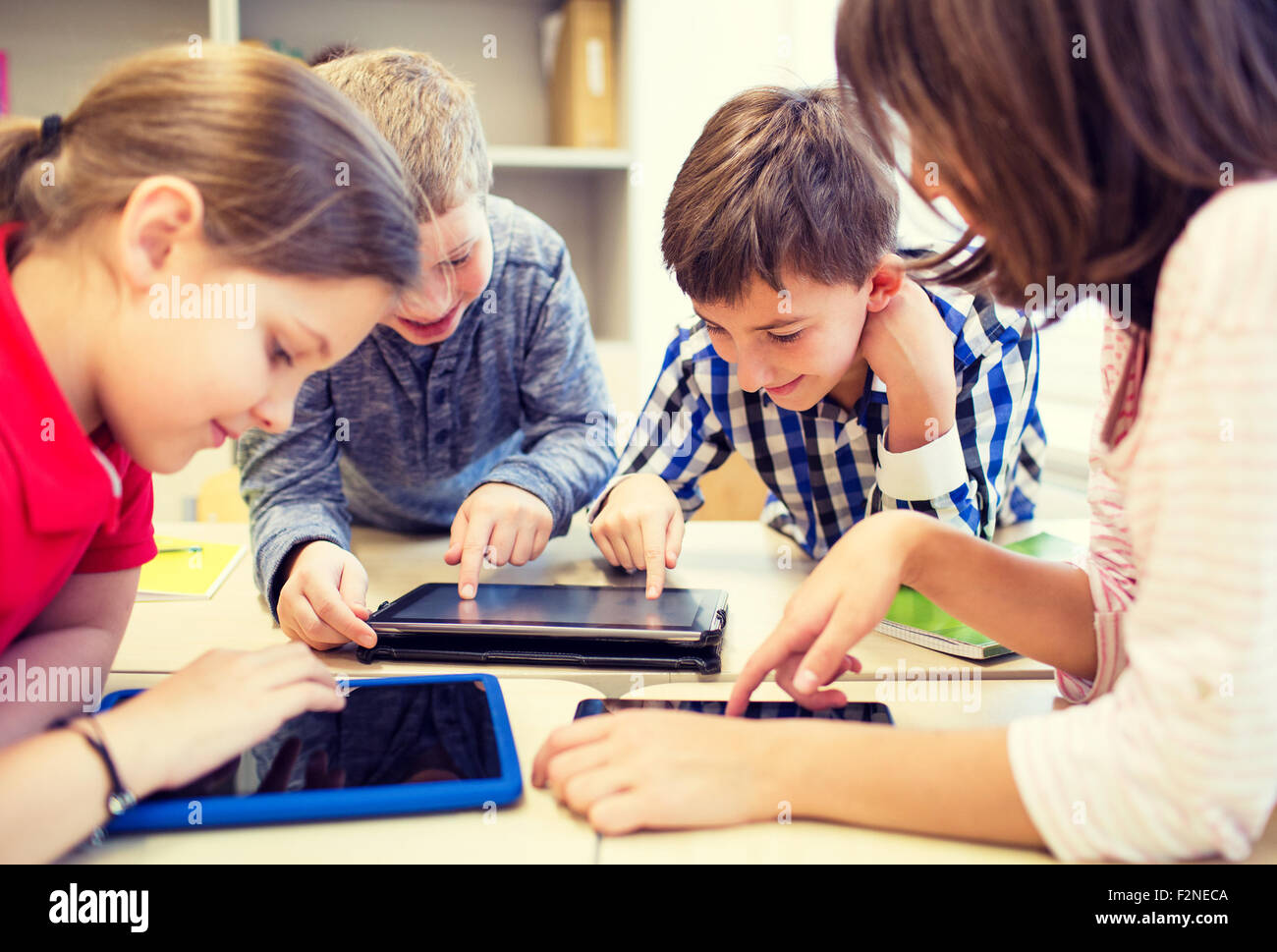 group of school kids with tablet pc in classroom Stock Photo - Alamy