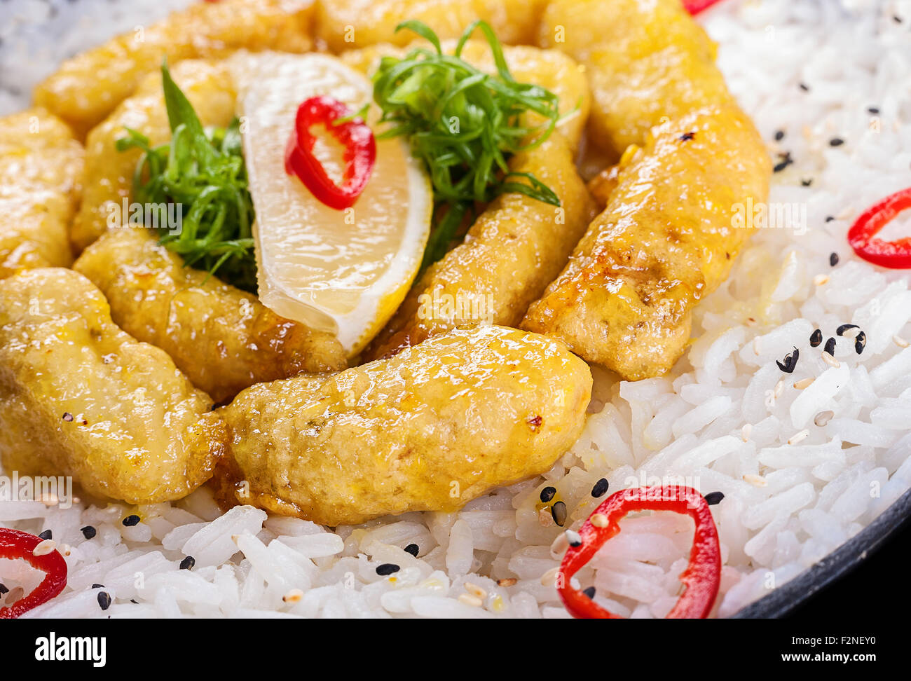 Meat in batter with white rice closeup Stock Photo - Alamy